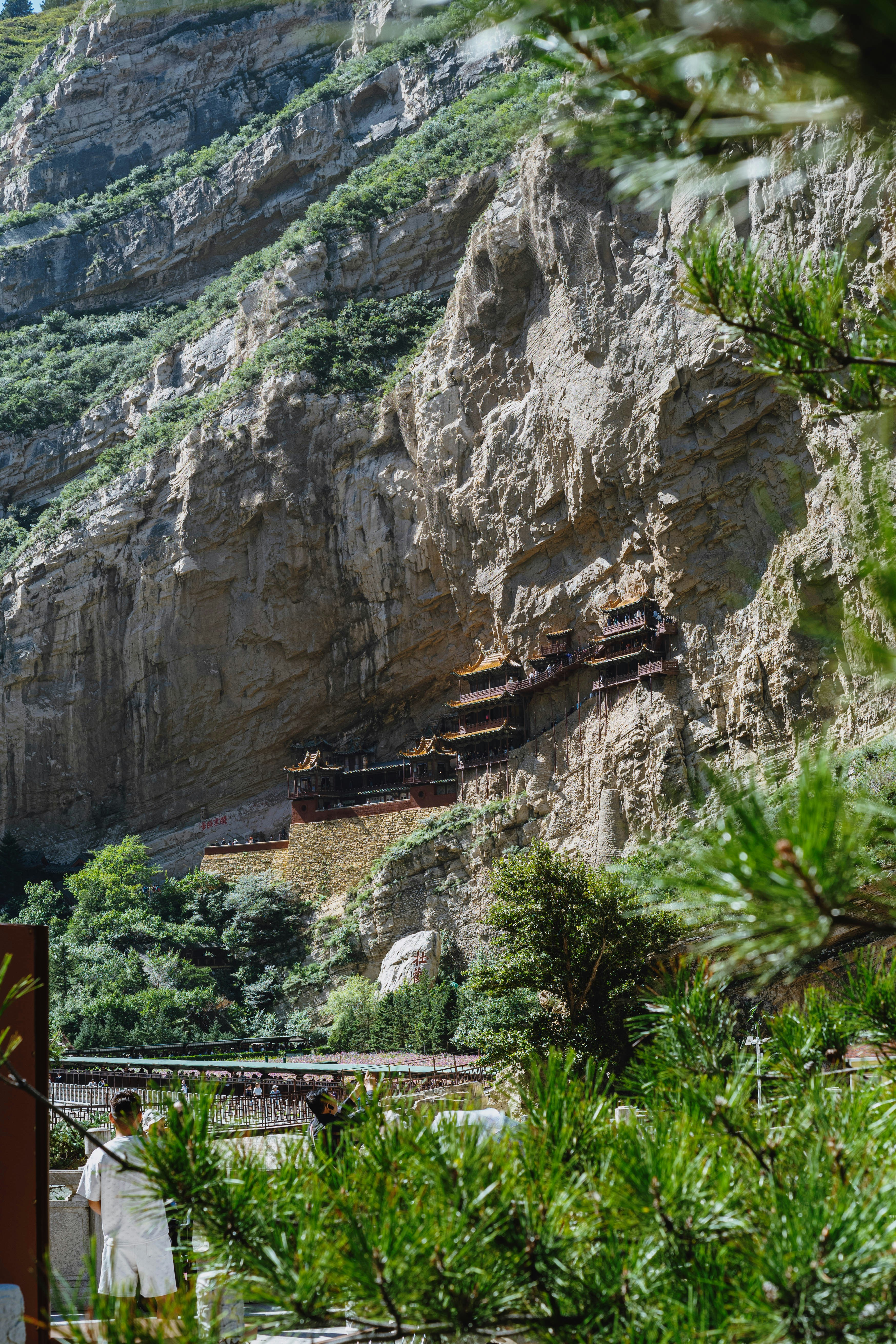 Temple complex built into a steep mountain cliff. photo – Free ...