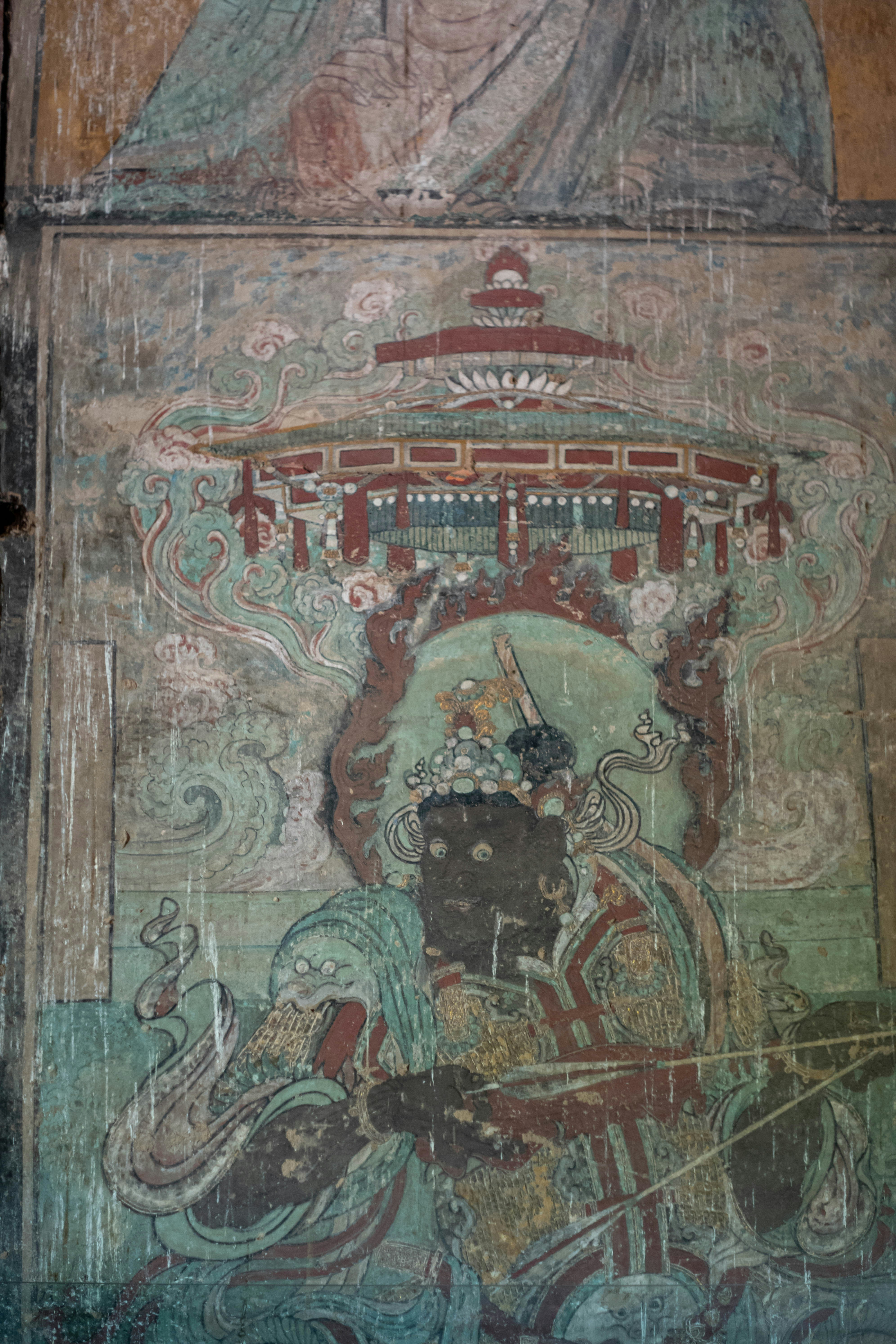 Vibrant mural depicting a fierce guardian figure amidst swirling clouds and ornate architecture. Rich colors and intricate details bring the historical scene to life.