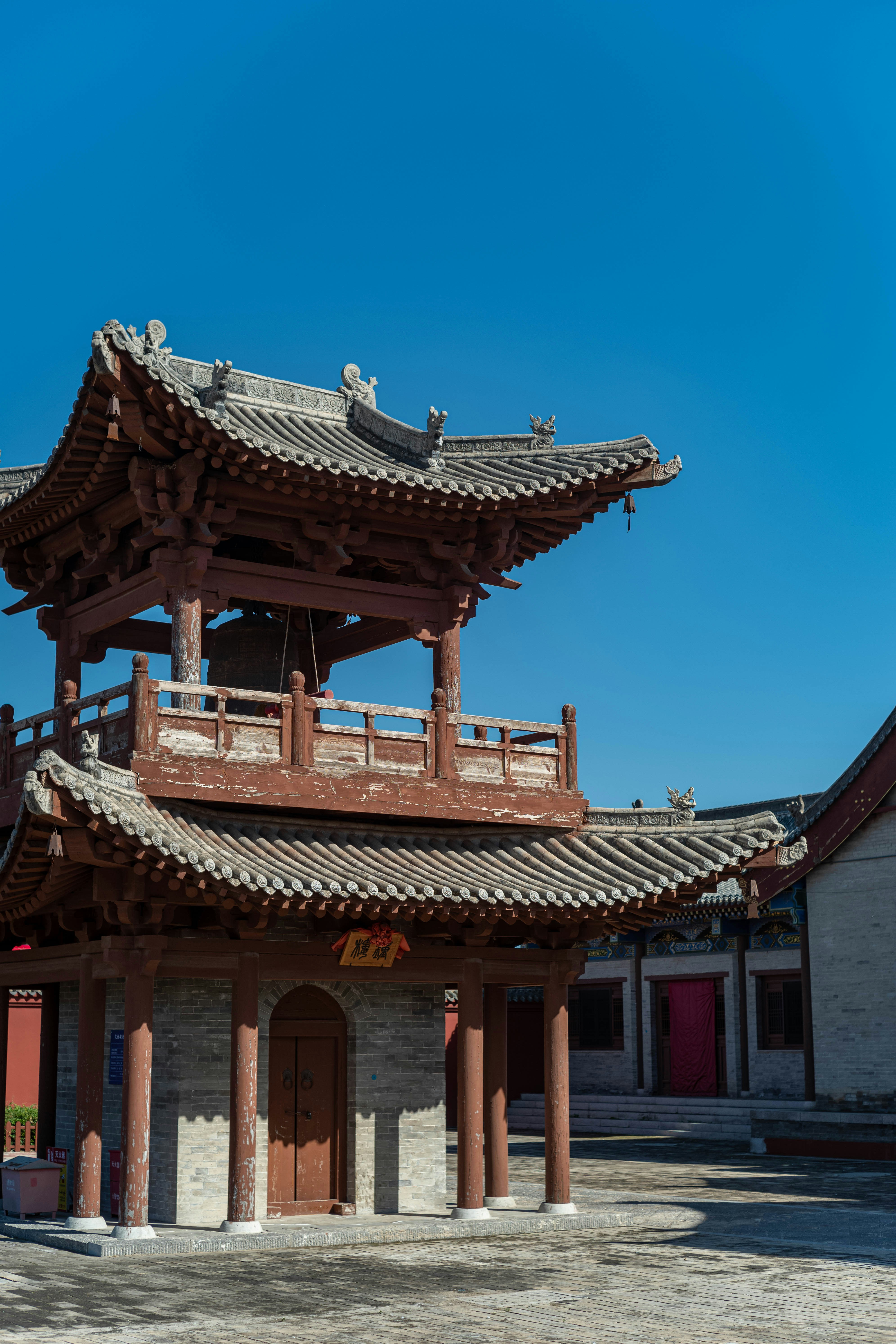 Traditional east asian pagoda structure against a clear blue sky.