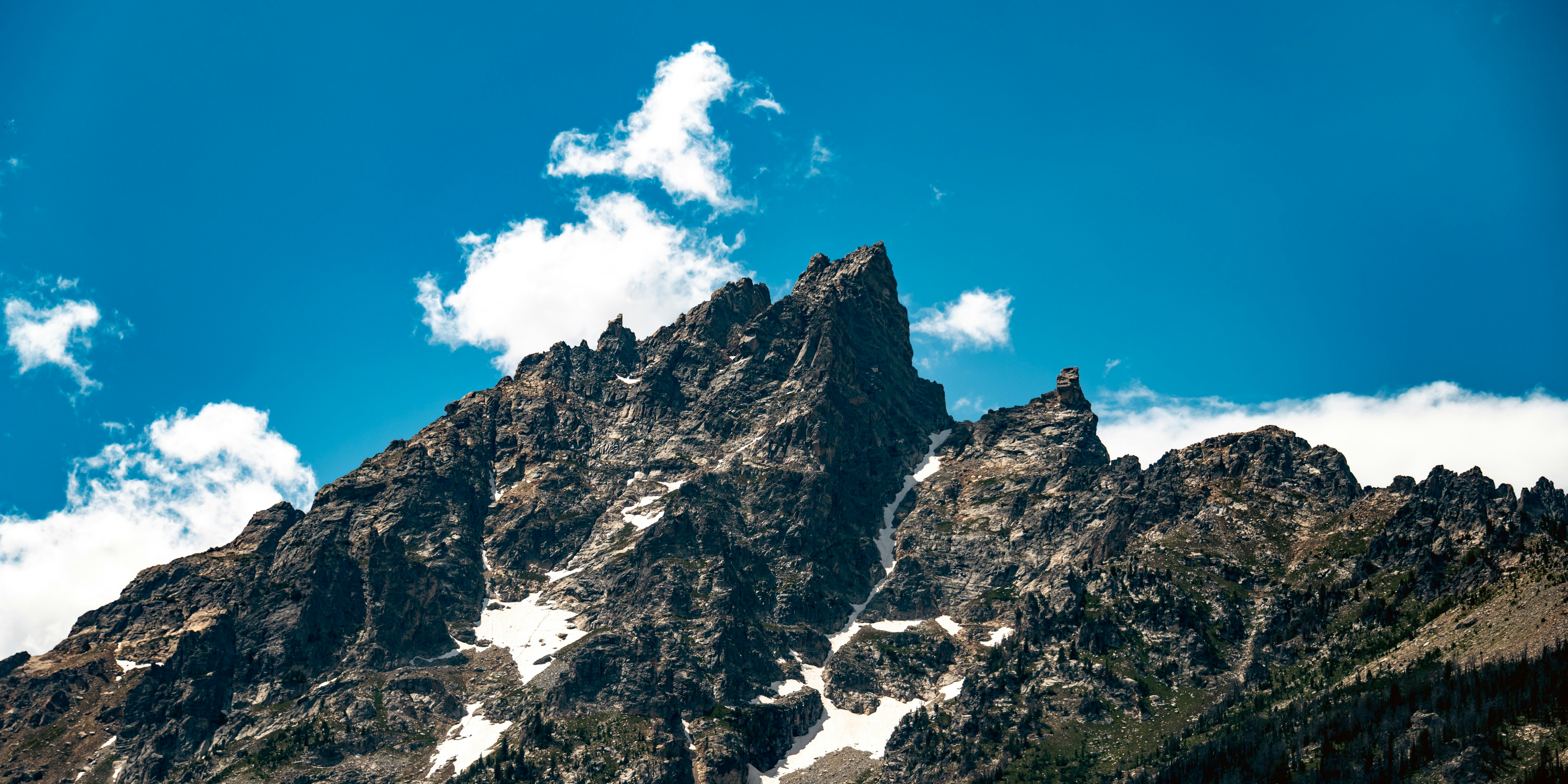 Jagged mountain peak under a bright blue sky.