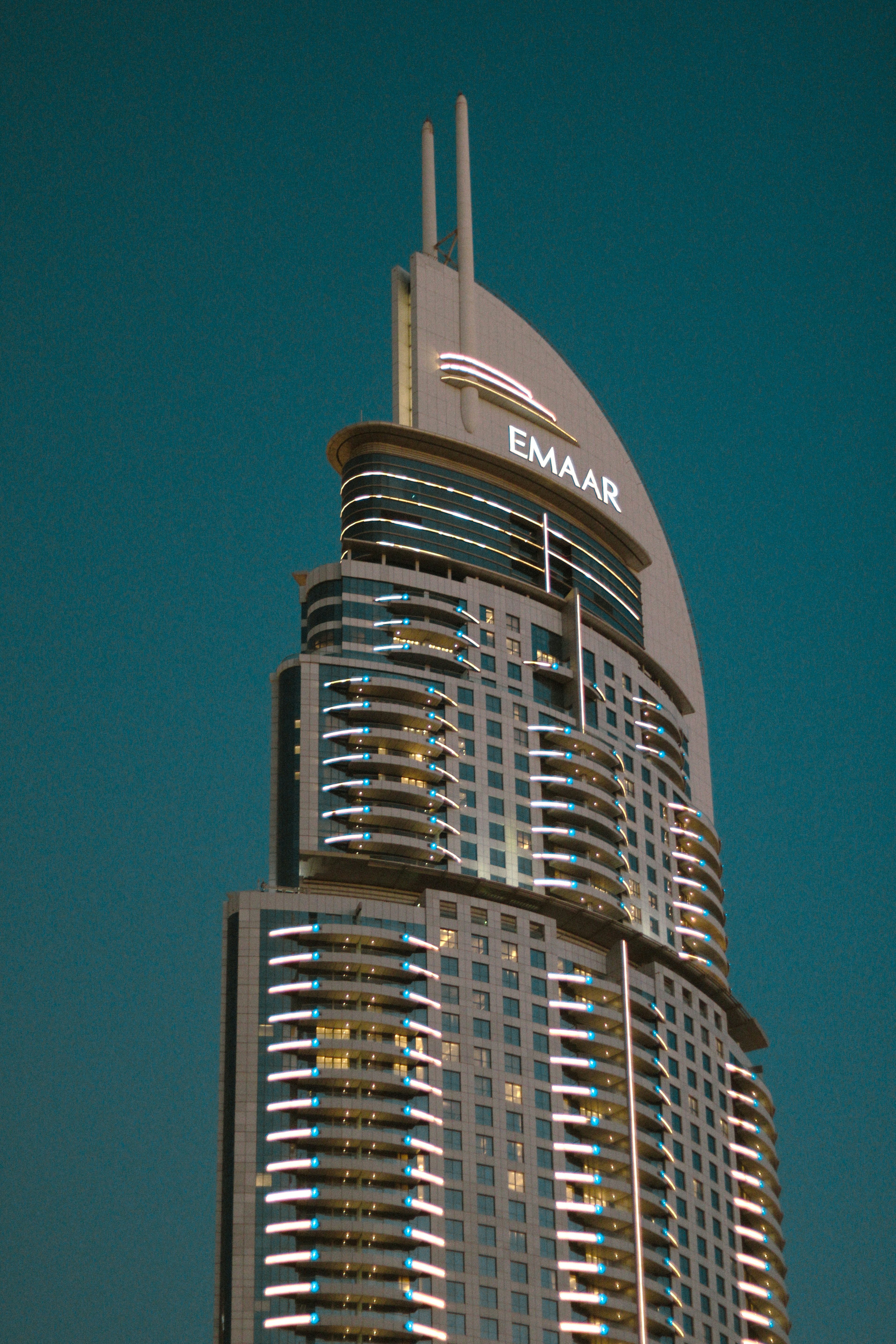 Address Hotel, Dubai | Modern skyscraper with emaar logo against blue sky