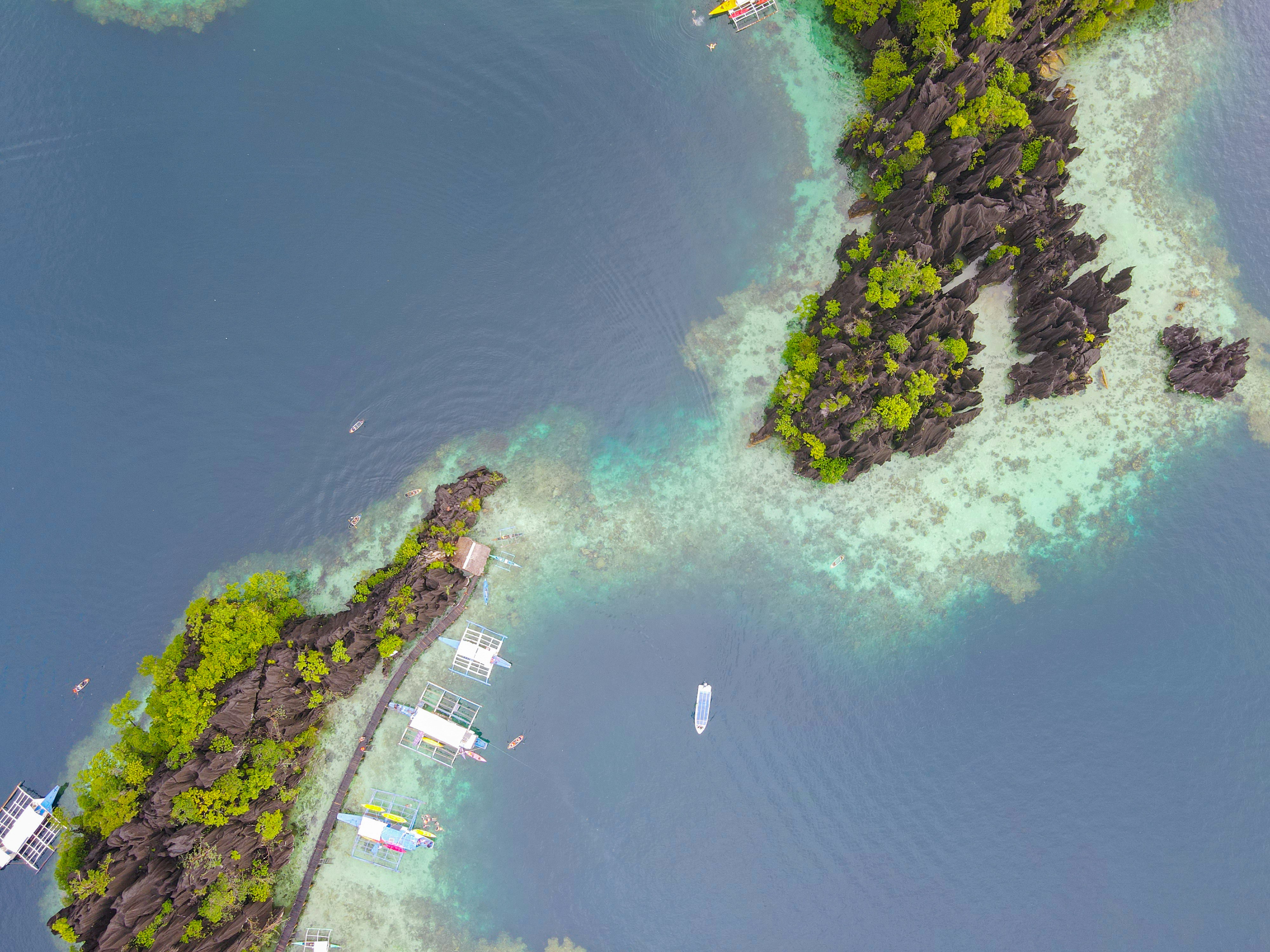 Aerial view of islands with boats in clear blue water