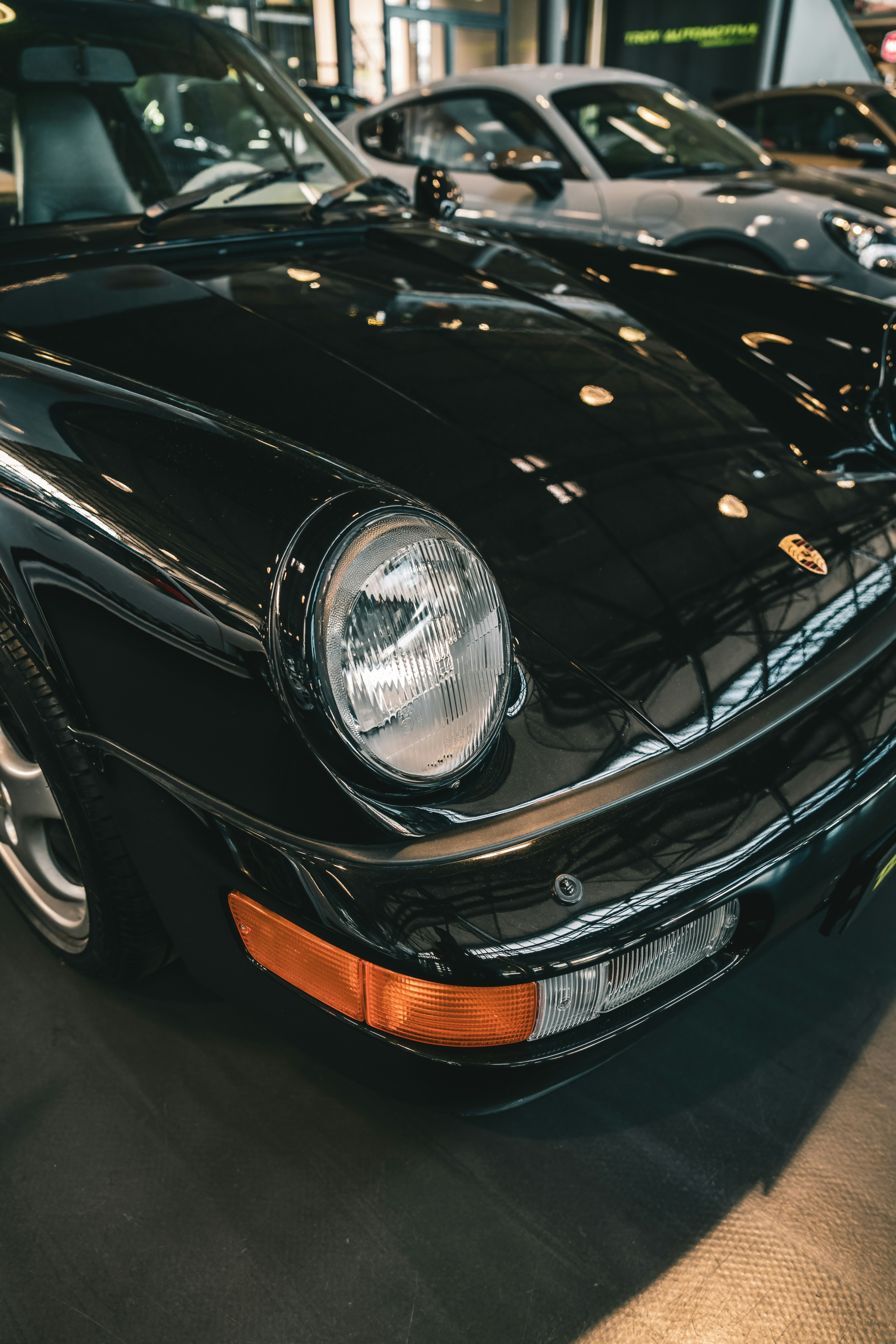 Close-up of a sleek black sports car headlight.