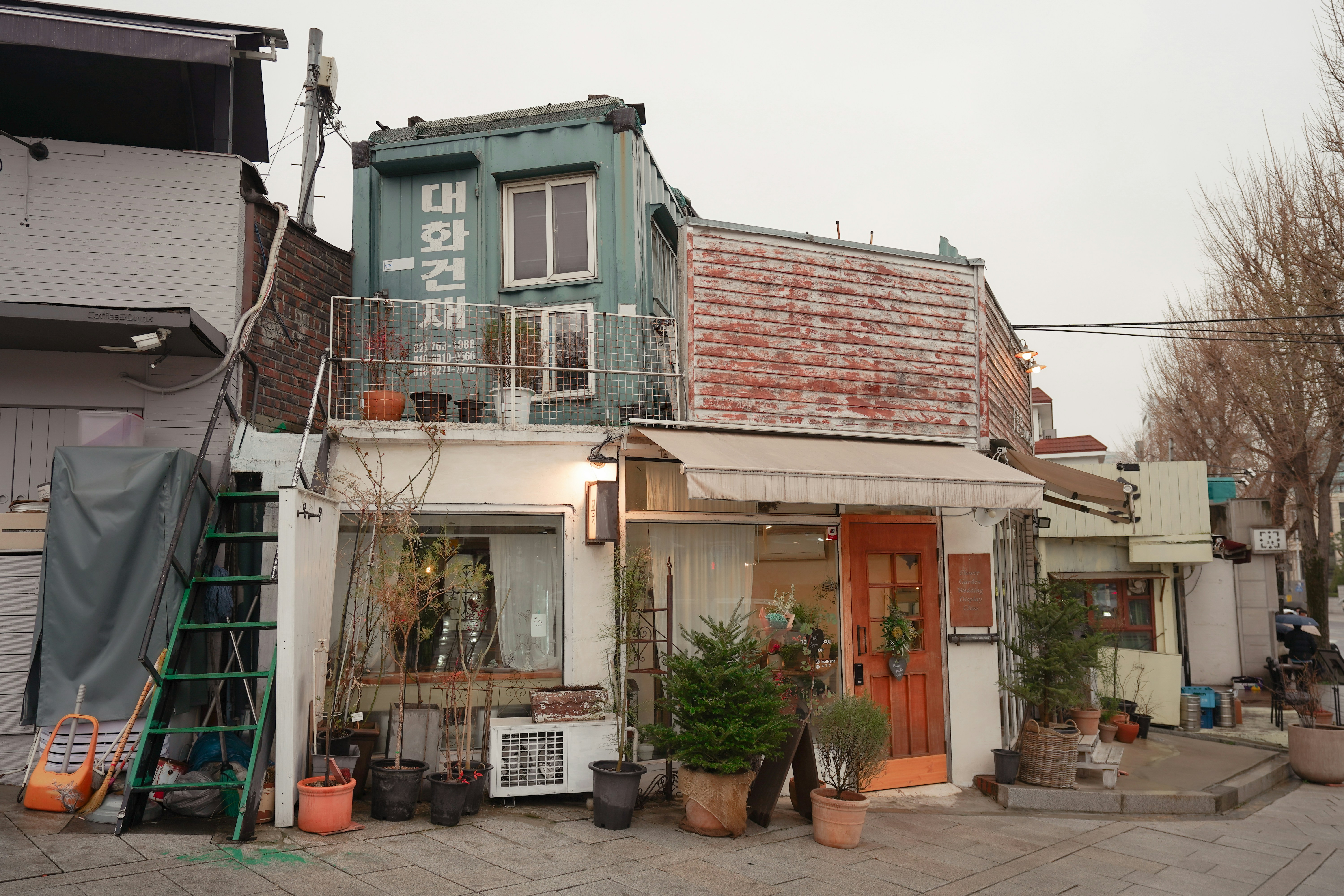 Small shop with container on top in urban setting.