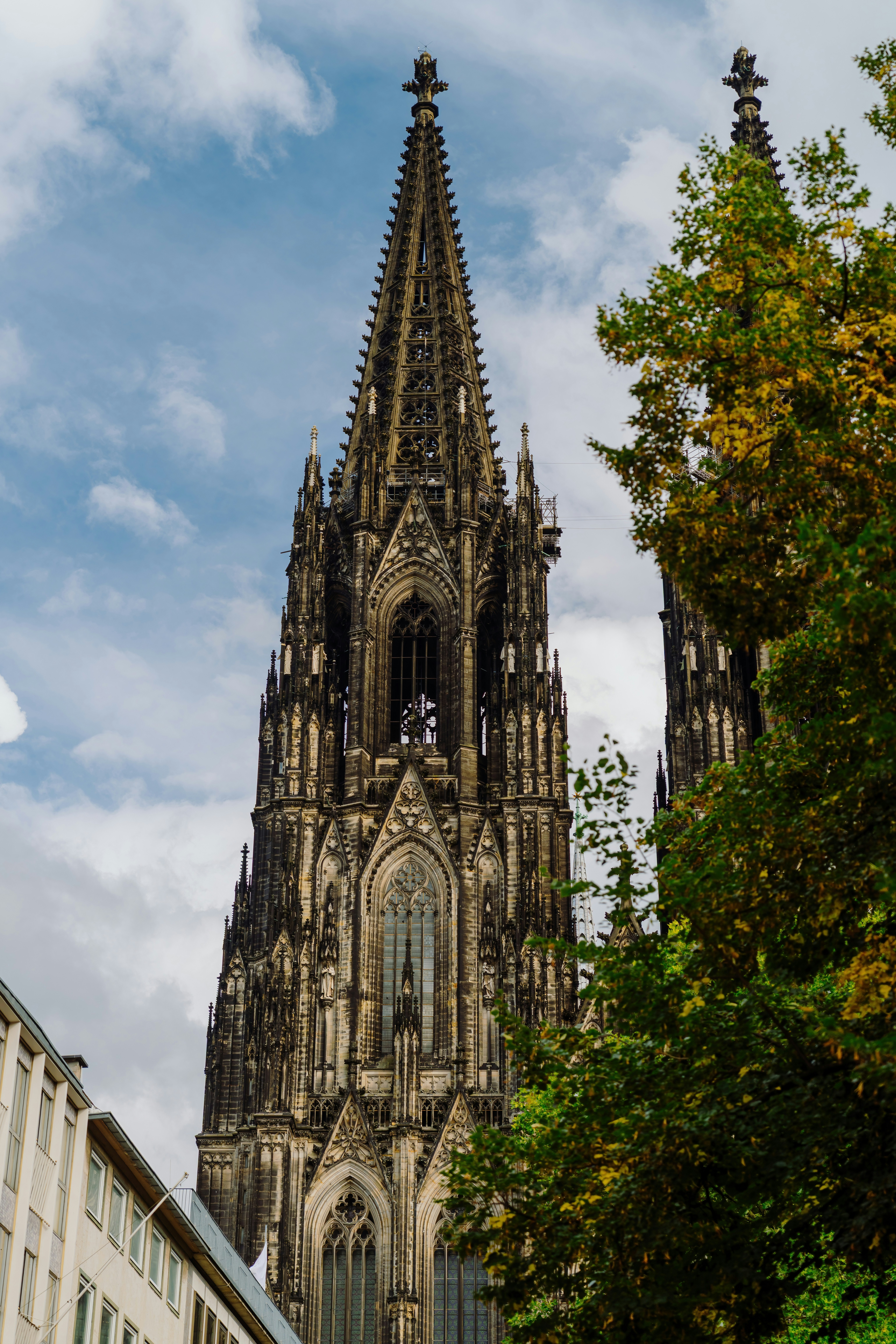 Gothic cathedral spire against a cloudy sky