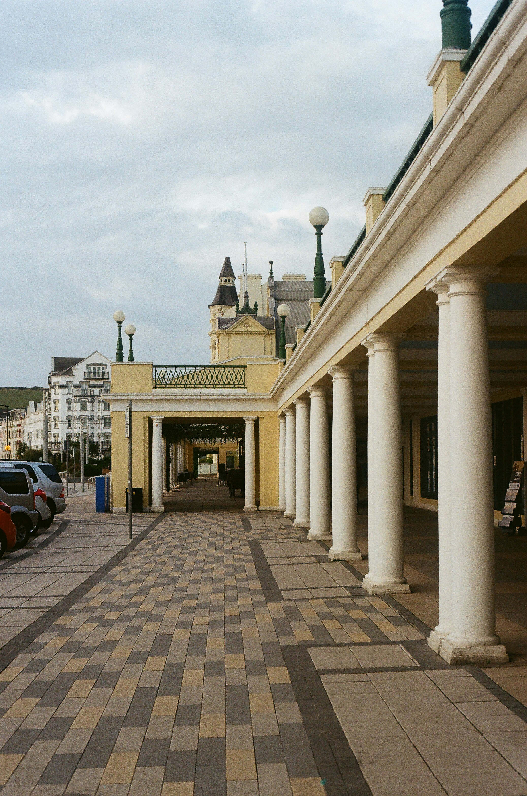 Elegant colonnade with patterned walkway and buildings photo – Free ...