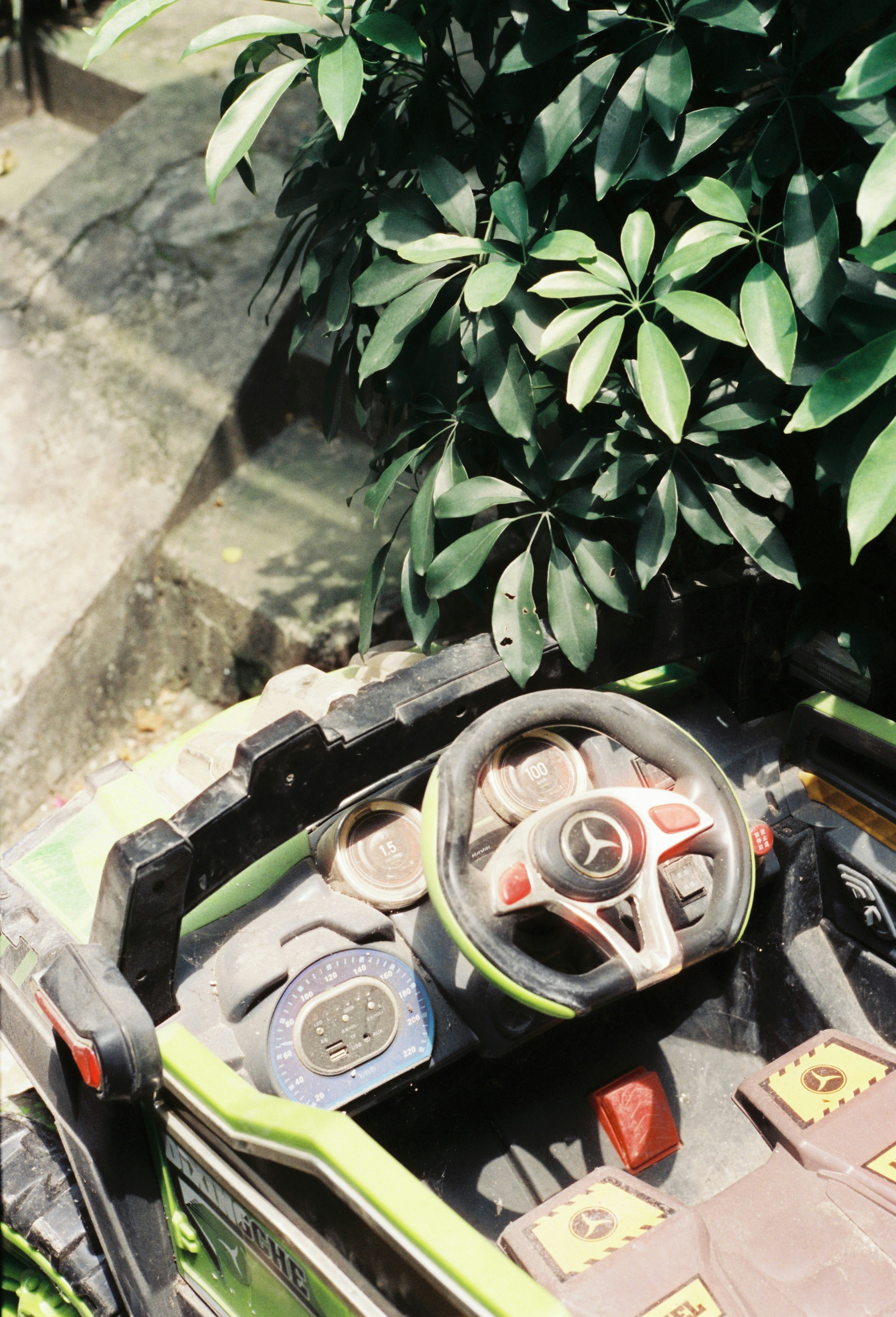 Green toy car dashboard with steering wheel