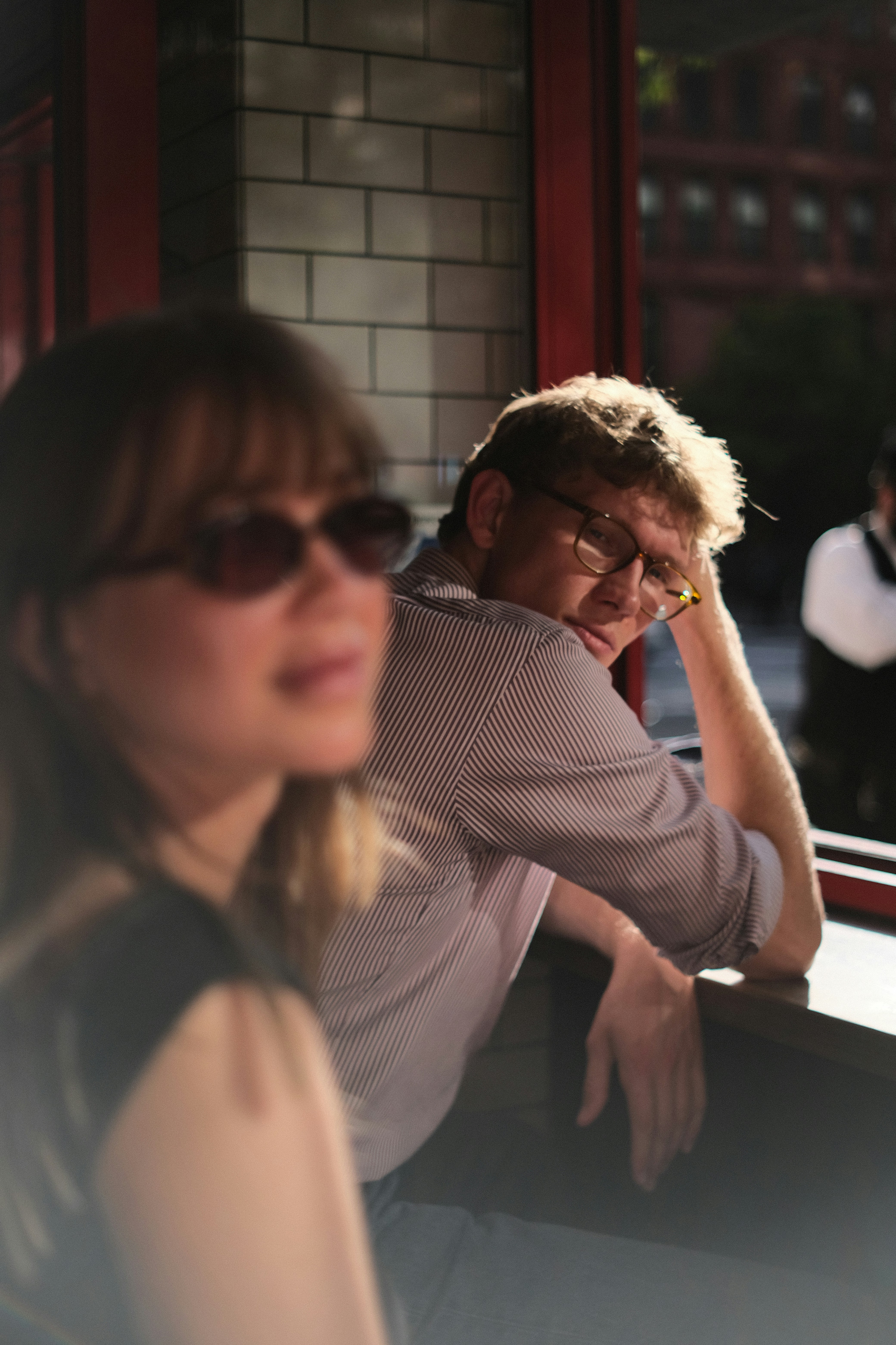 SOOC JPEG. Fuji XT30. NYC. Sept 2025. | Man in glasses rests head on hand near woman.