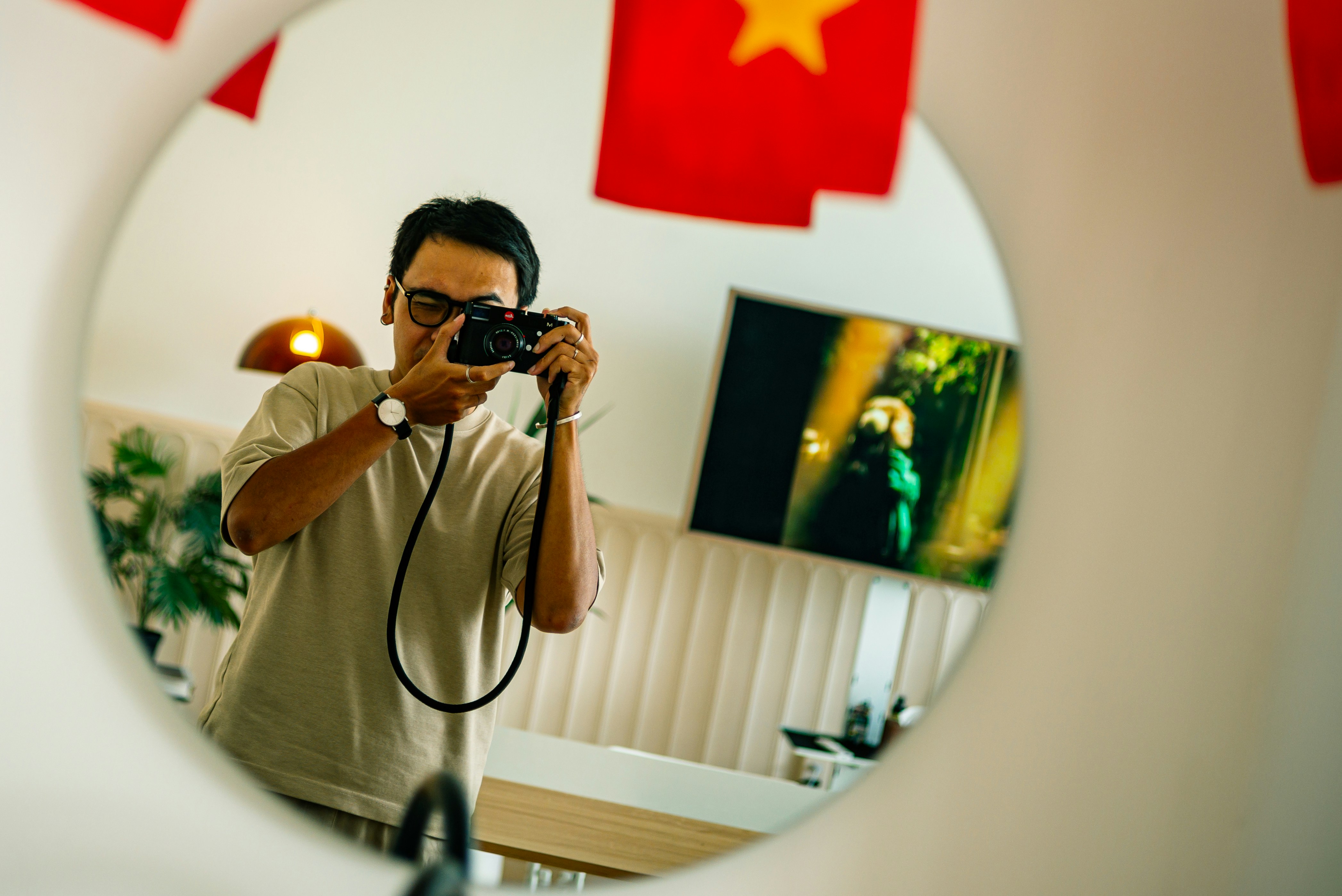 Man taking a selfie in a round mirror