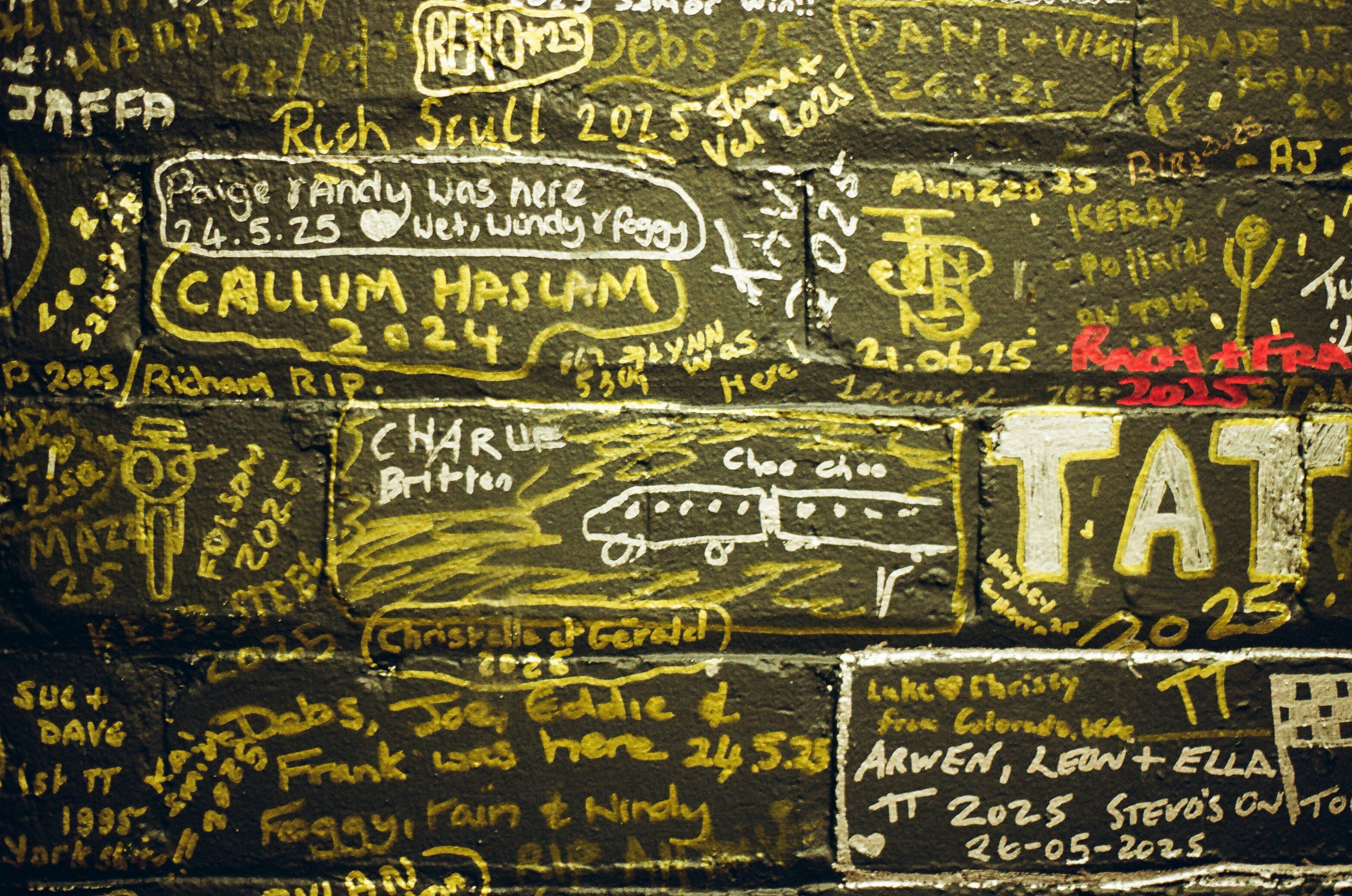 Brick wall covered in chalk graffiti and messages. photo – Free Brick ...