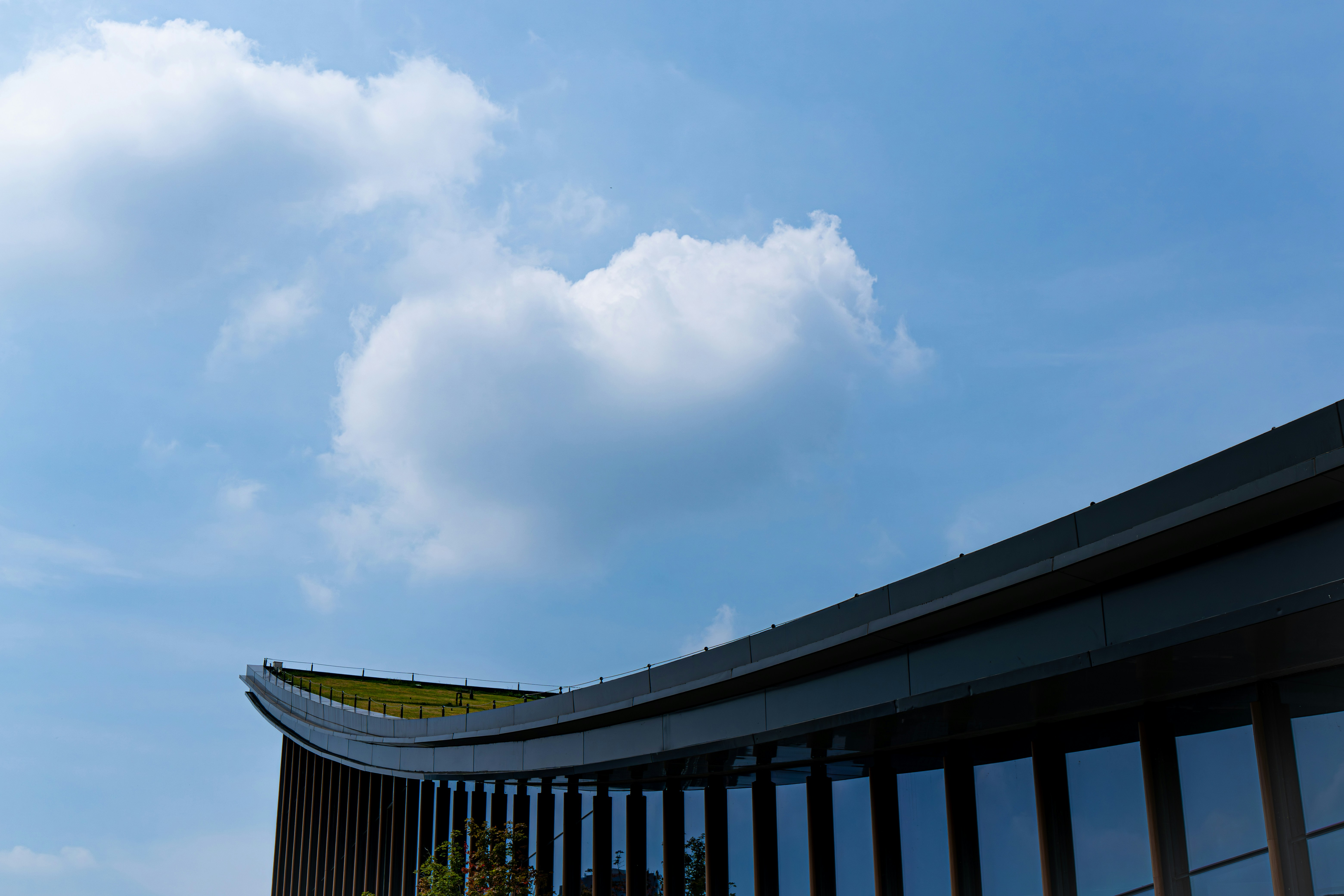 Cerulean Sky Framing a Golden-Trimmed Curved Colonnade
