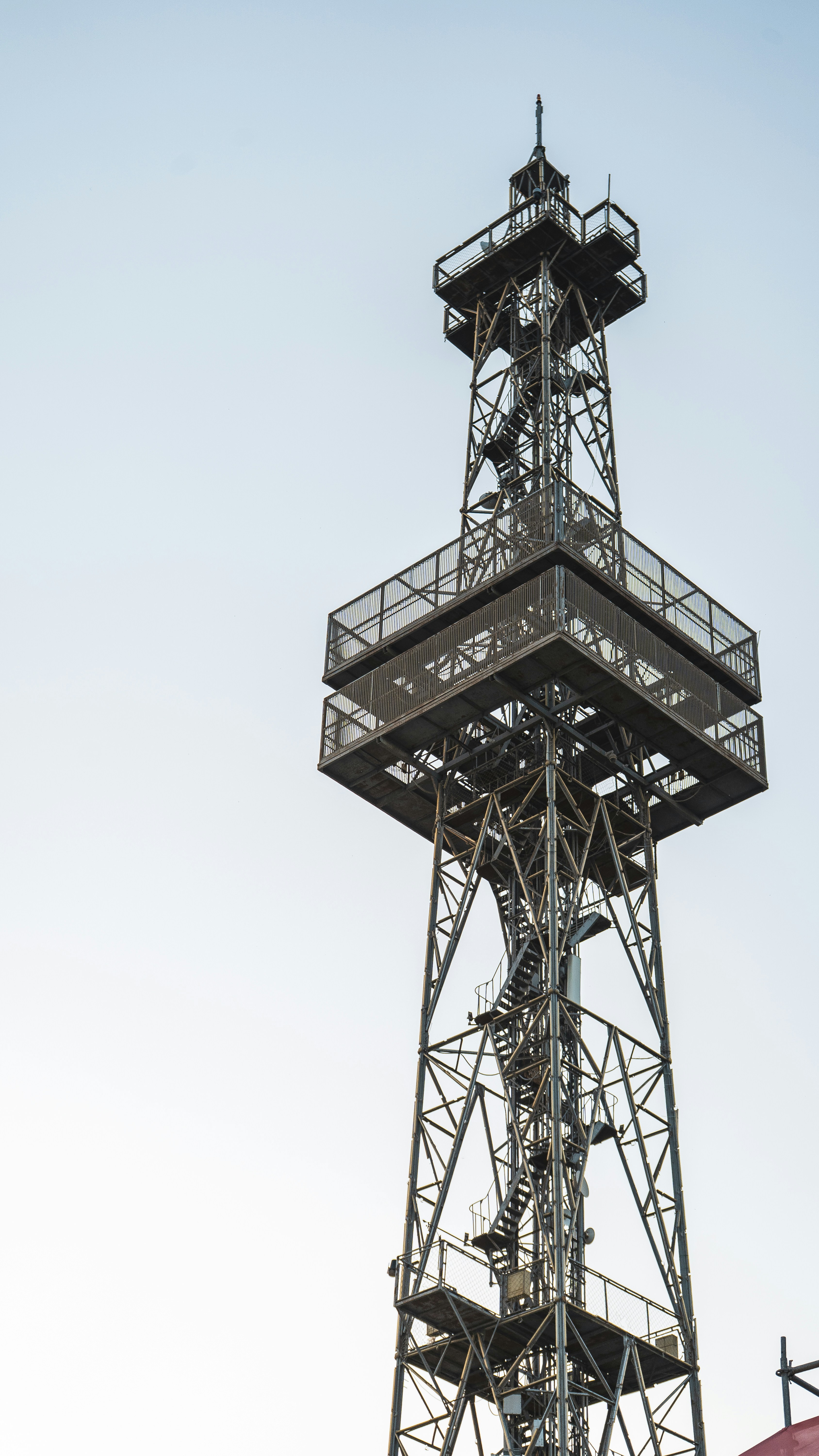 A tall metal observation tower against a clear sky