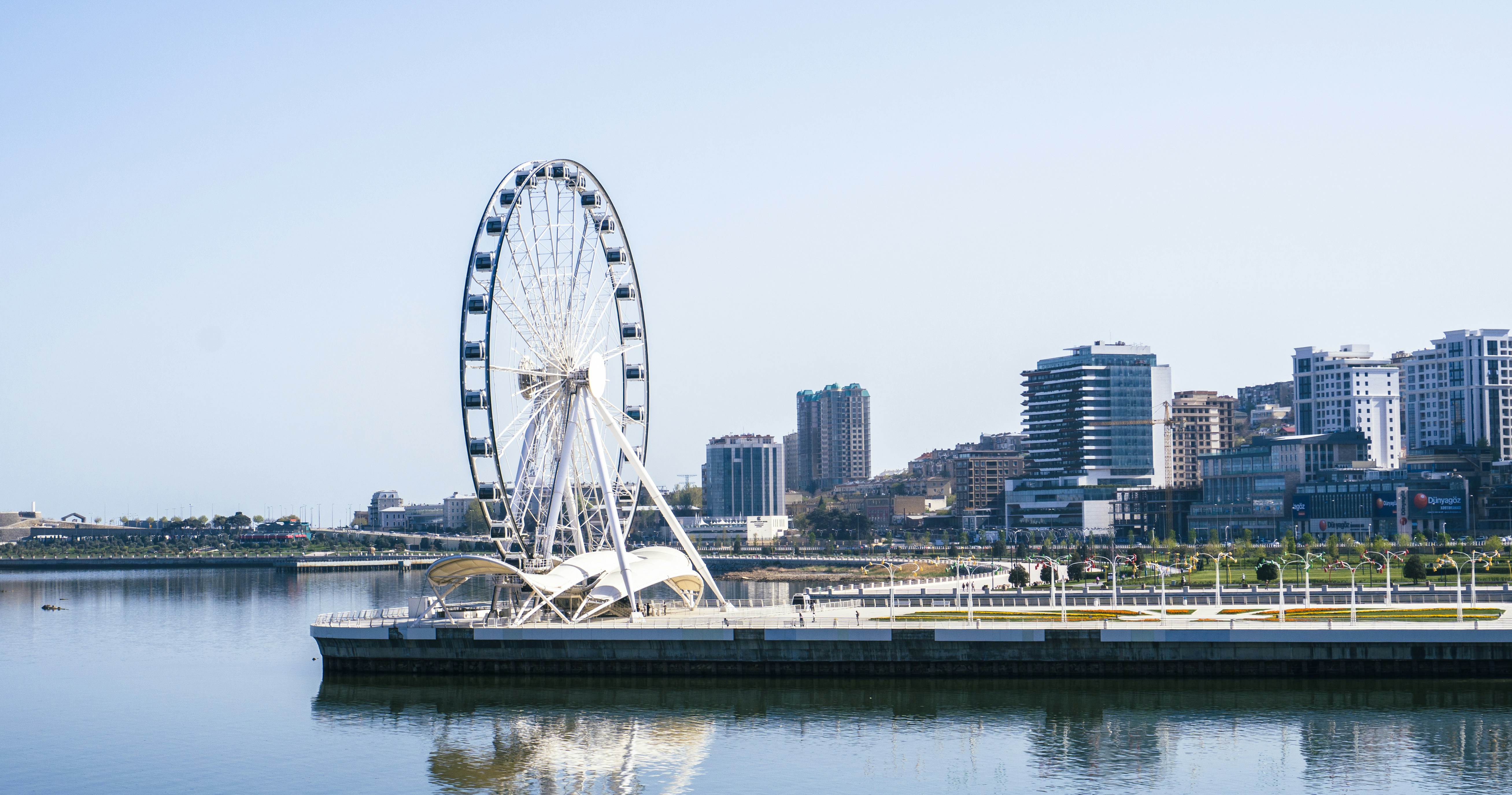Baku Ferris Wheel | Ferris wheel by the water with city skyline.