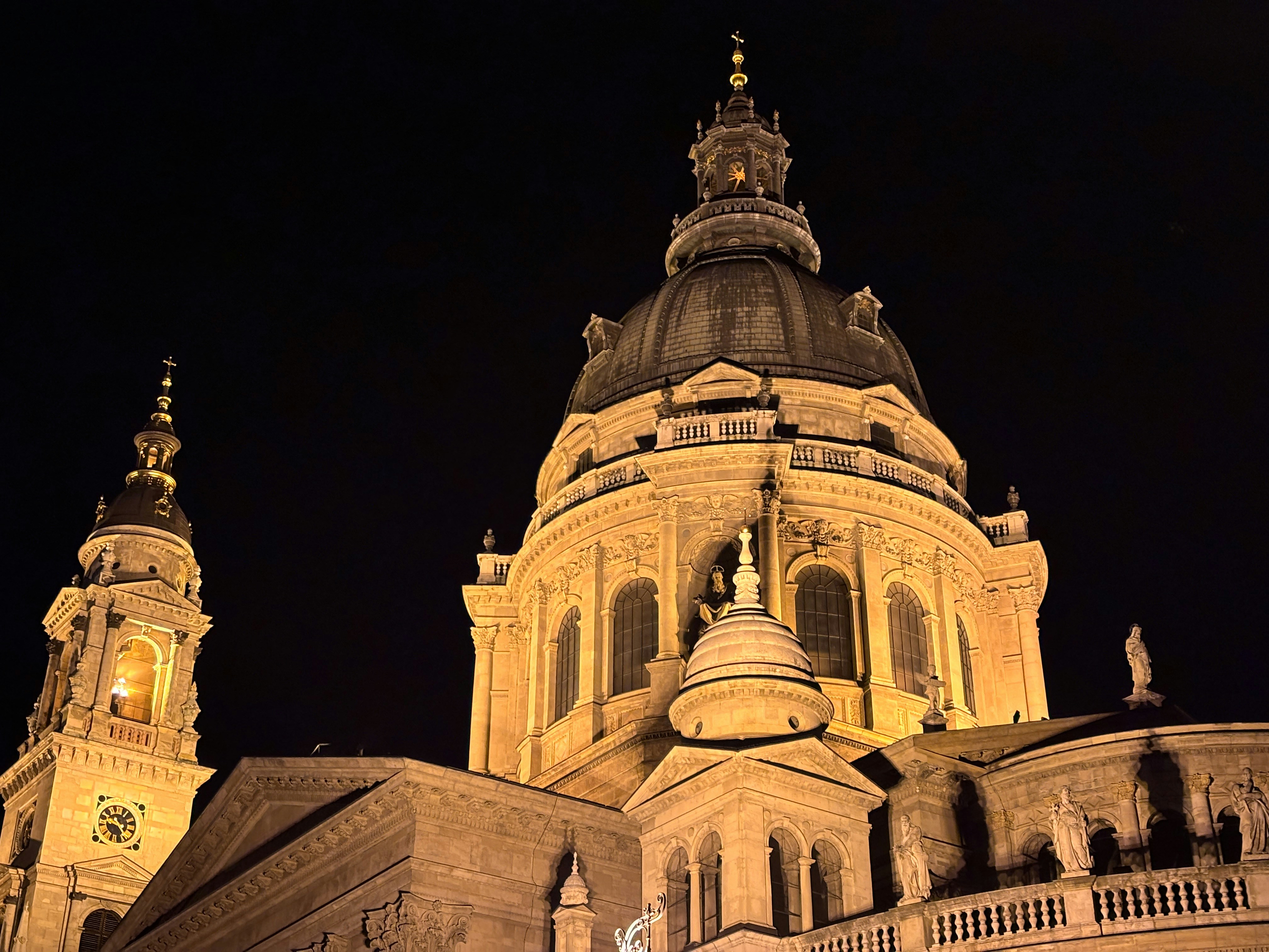 Ornate church domes illuminated at night against dark sky
