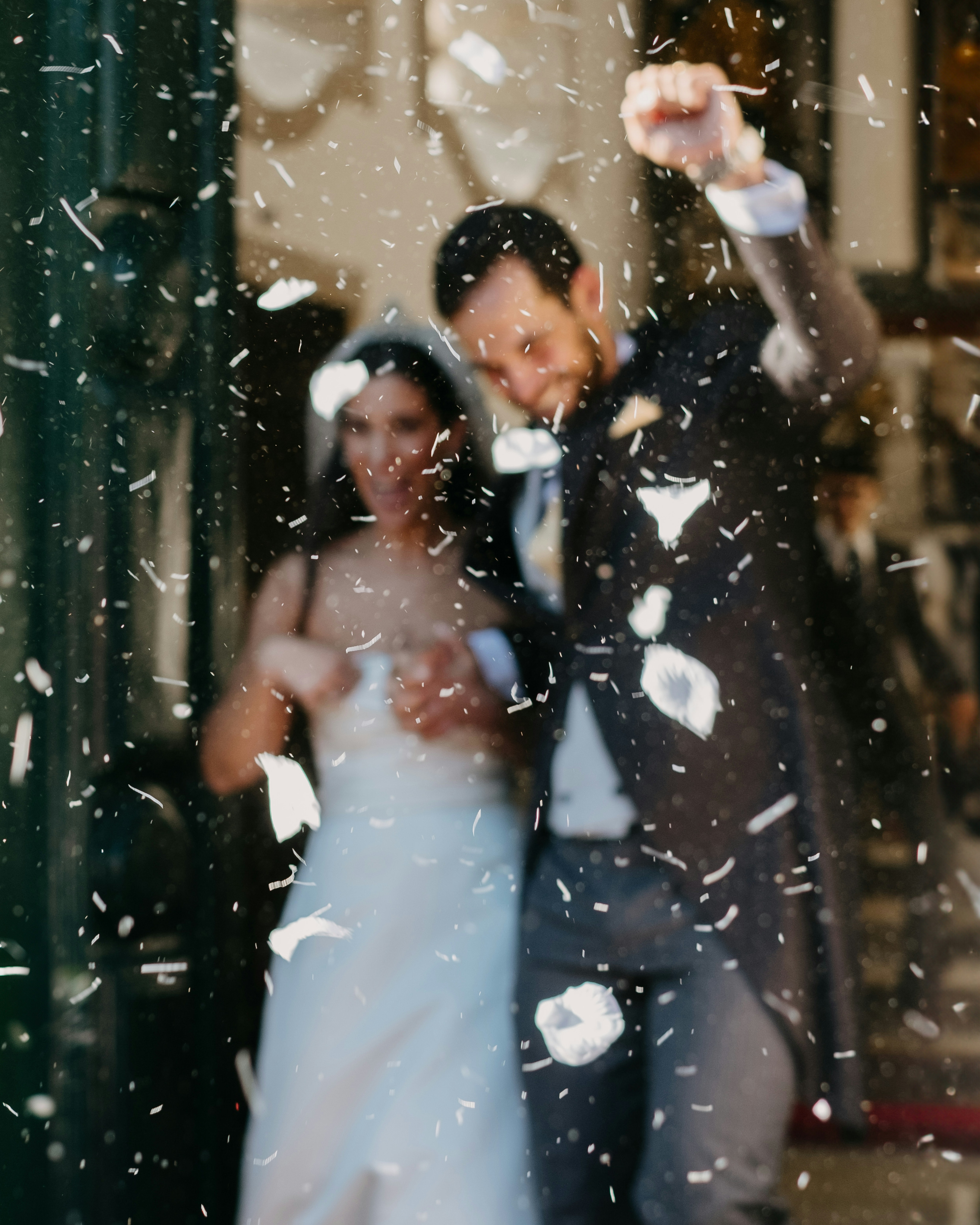 Newlyweds celebrate with falling confetti outside church photo – Free ...