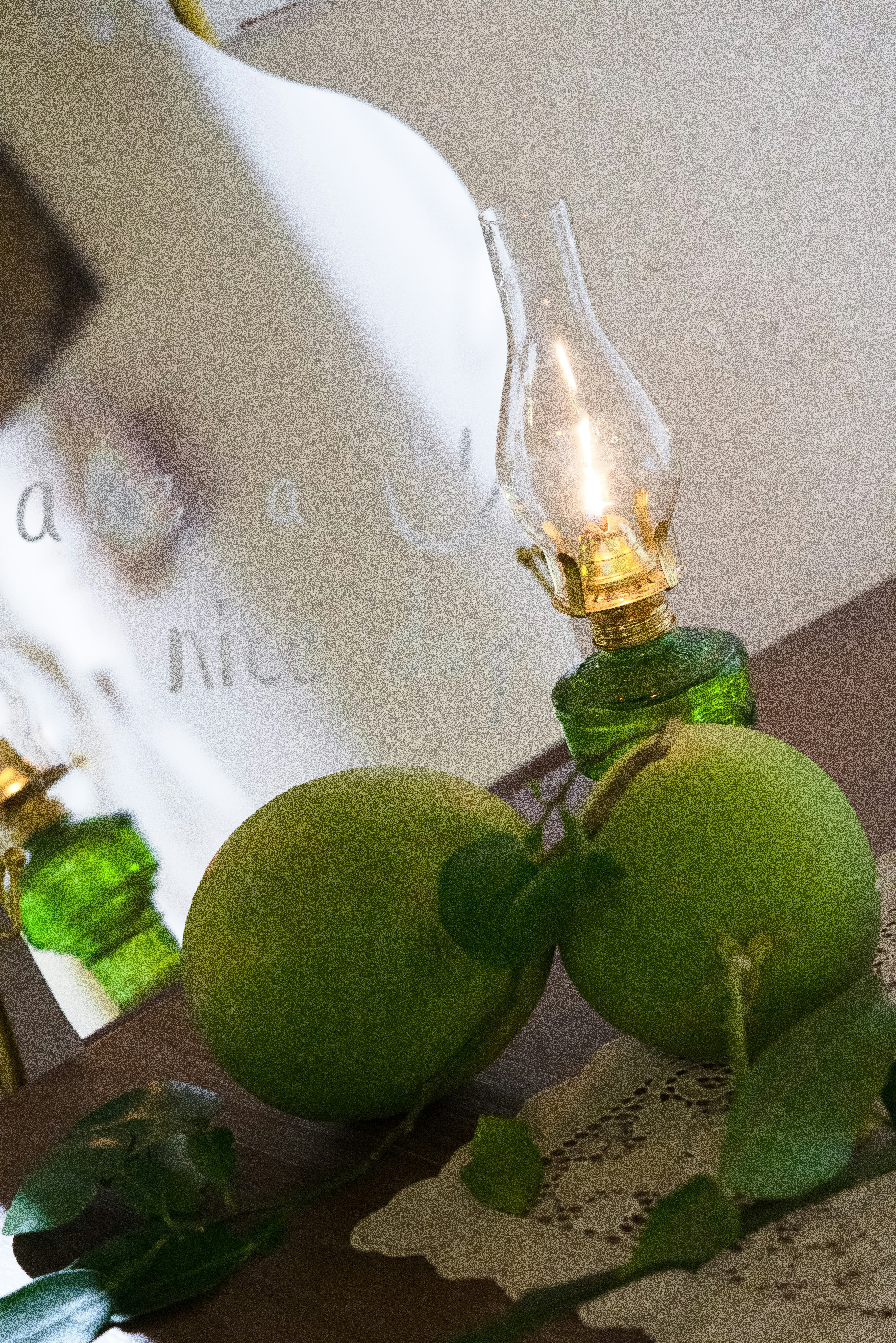 Two green fruits and a small oil lamp.