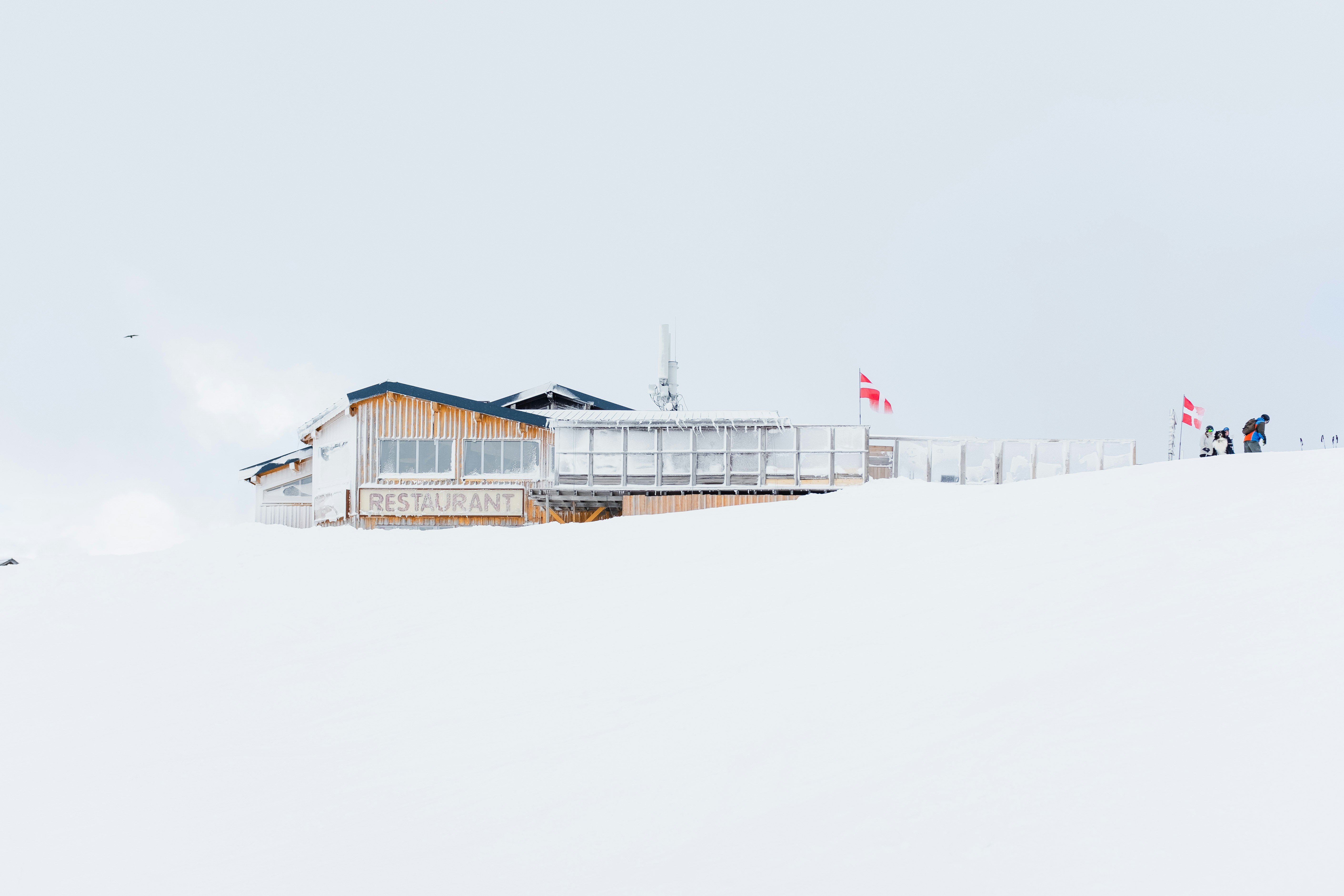 A mountain lodge sits on a snowy slope.