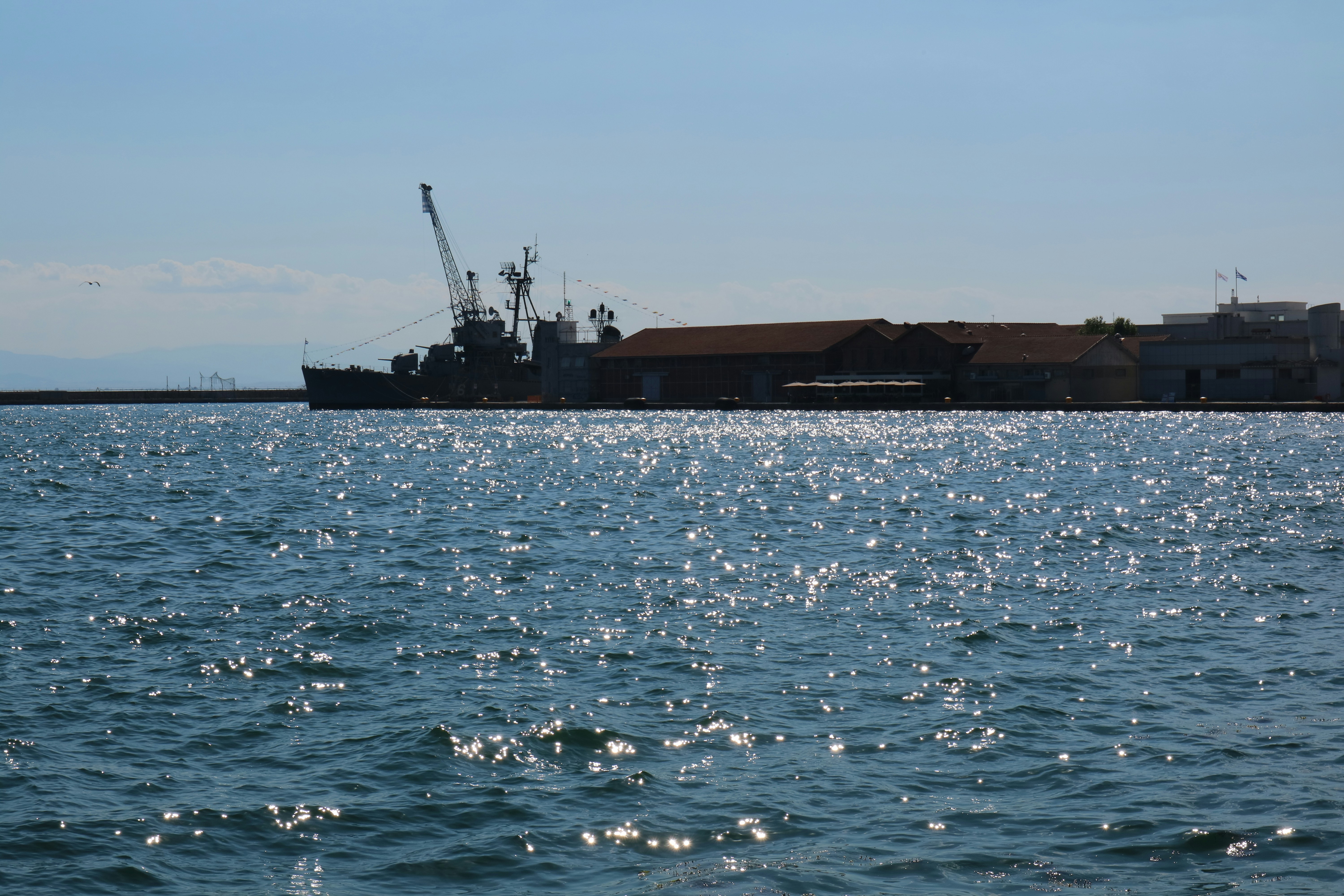 Ship docked at a harbor with sparkling water