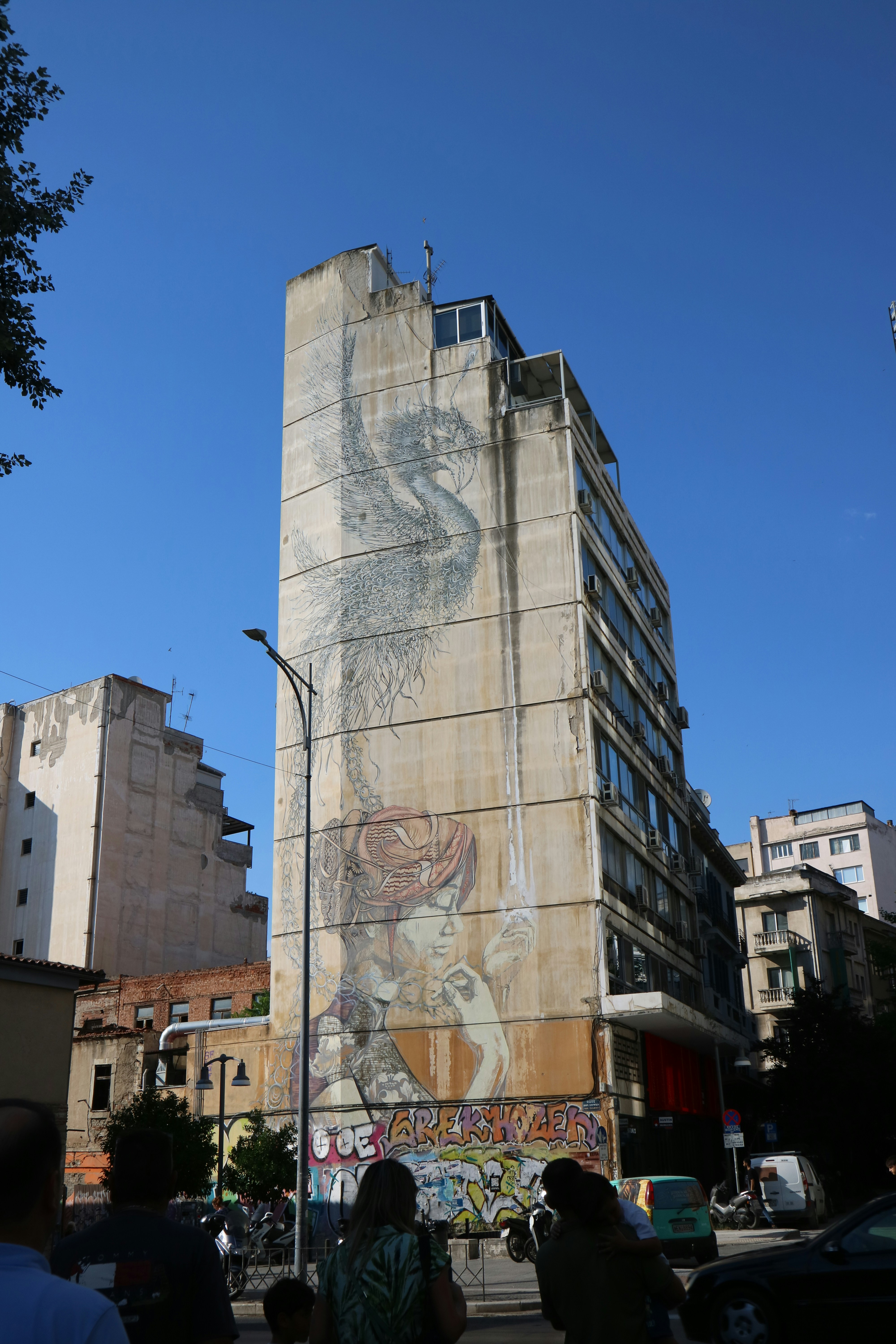 Tall building with large mural art on facade.