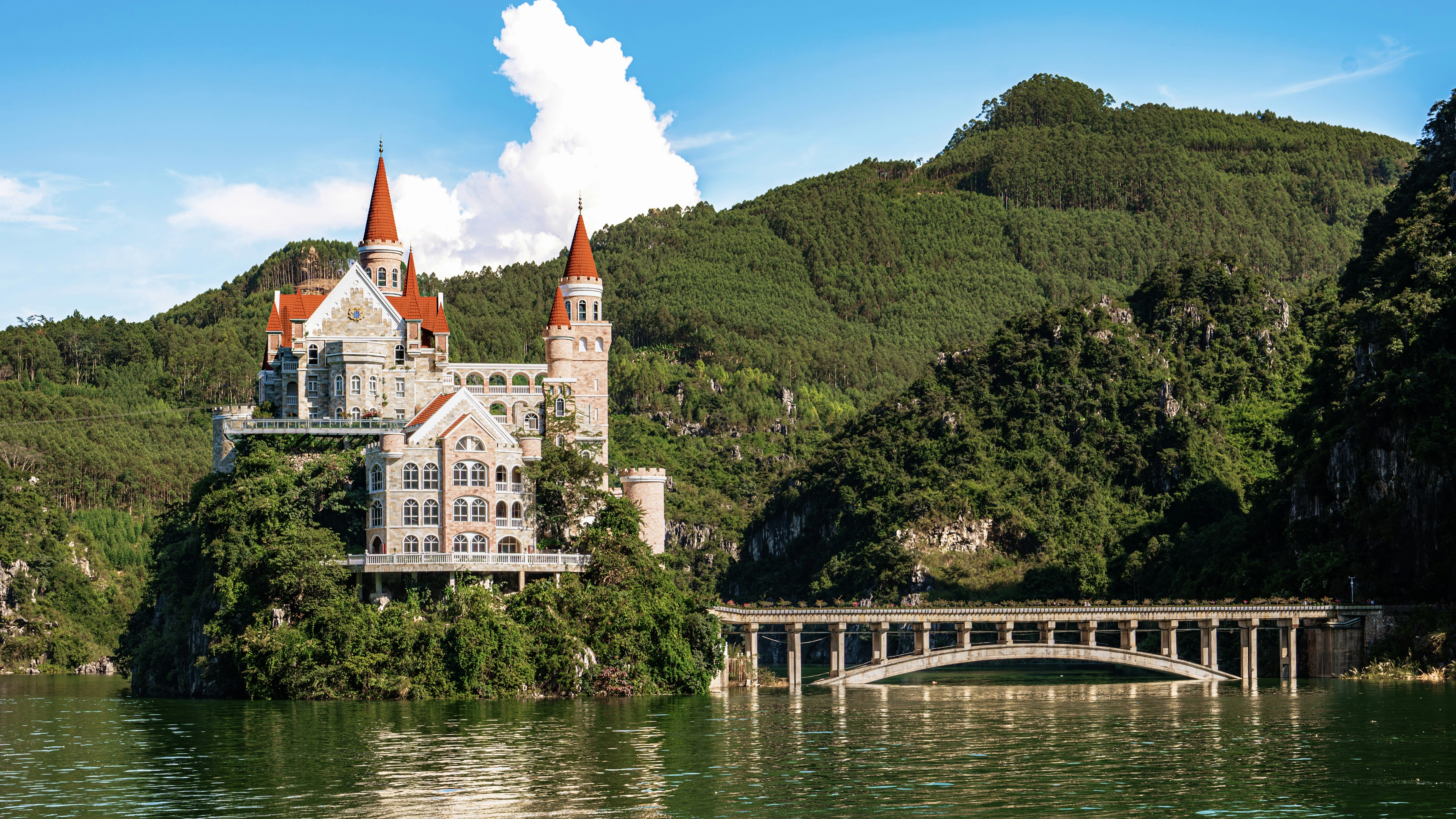 Fairytale castle on a rocky island with a bridge.