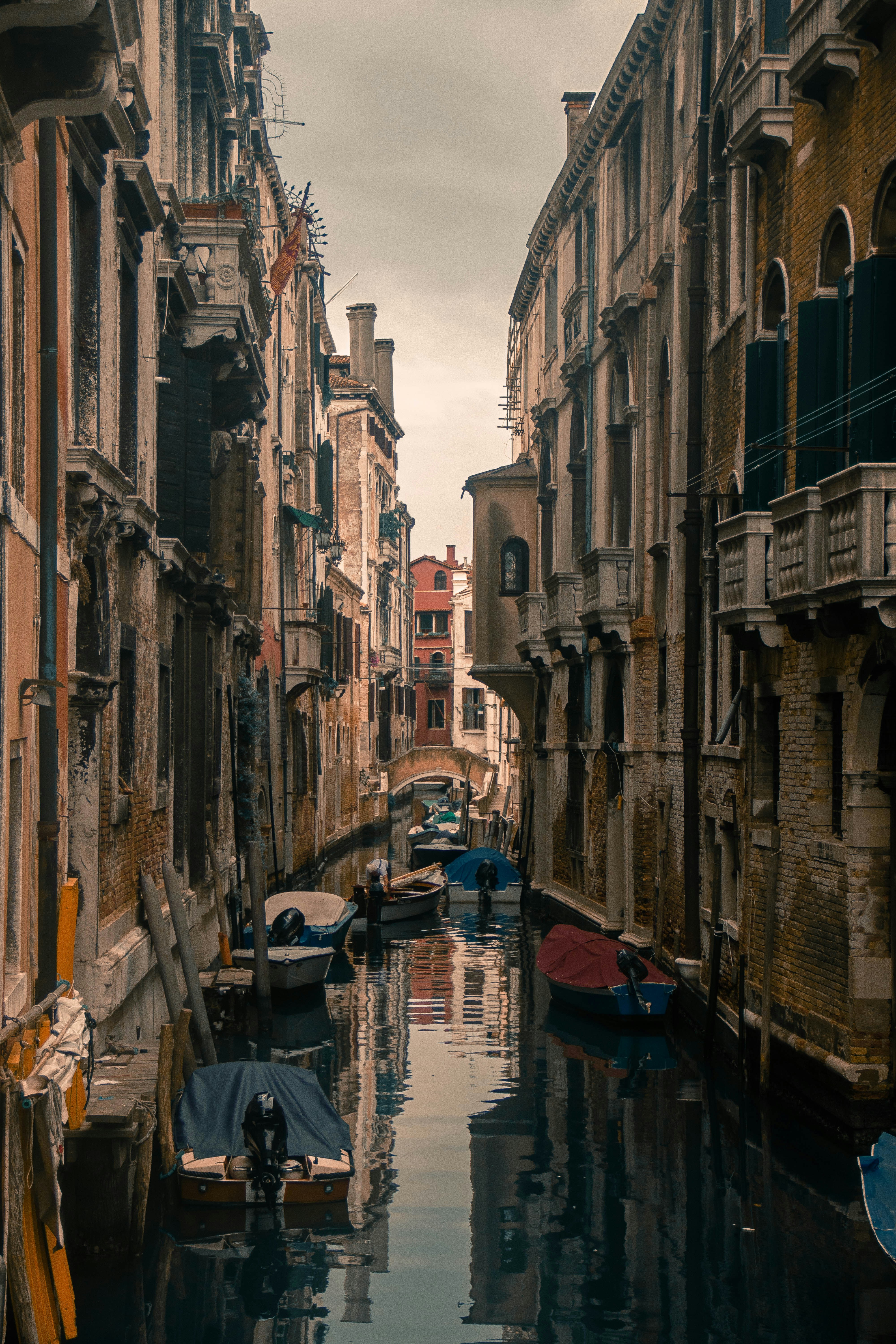 Venetian canal lined with old buildings and boats.