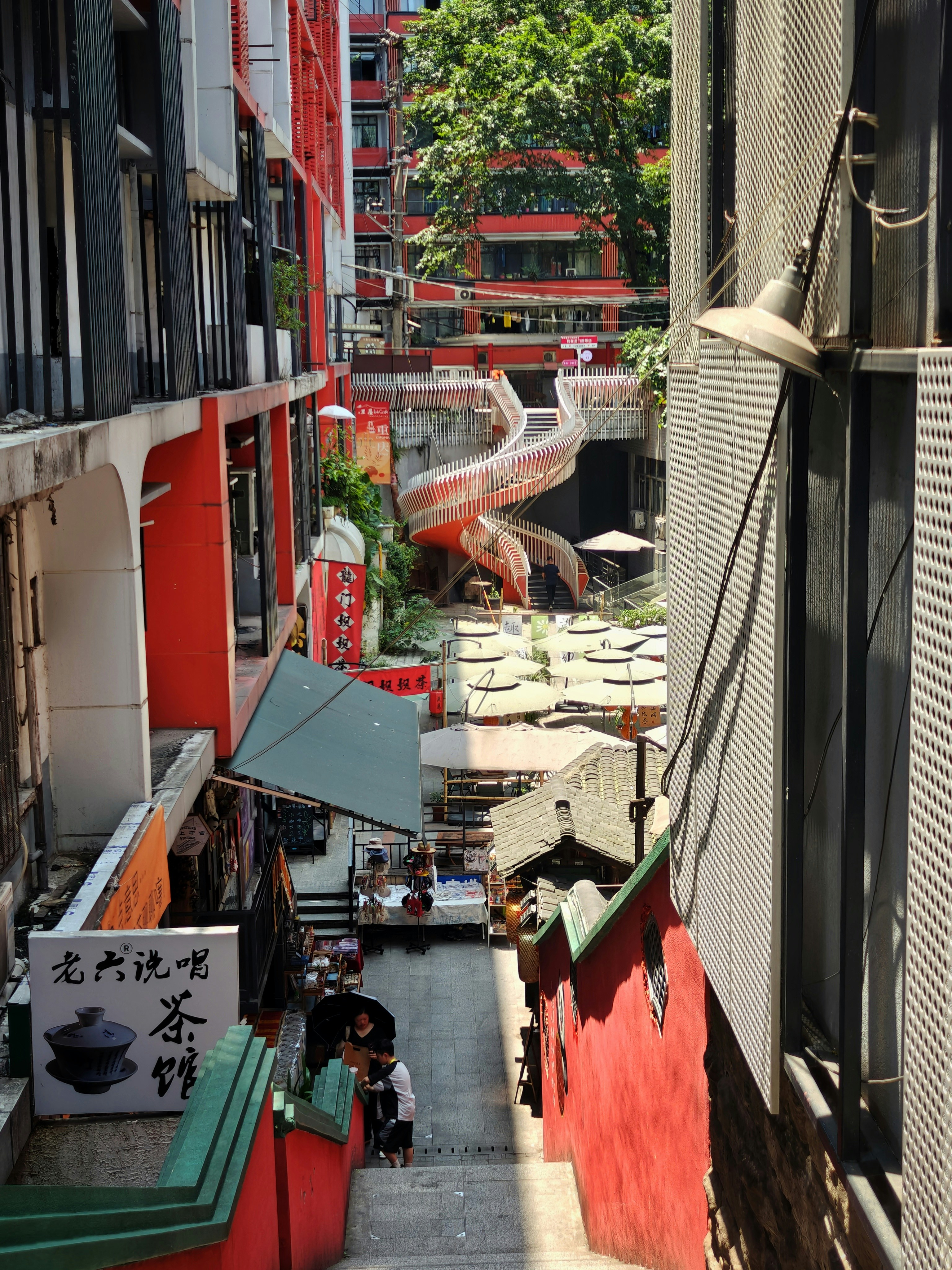Streets in Chongqing. | Narrow alleyway with colorful buildings and a slide.