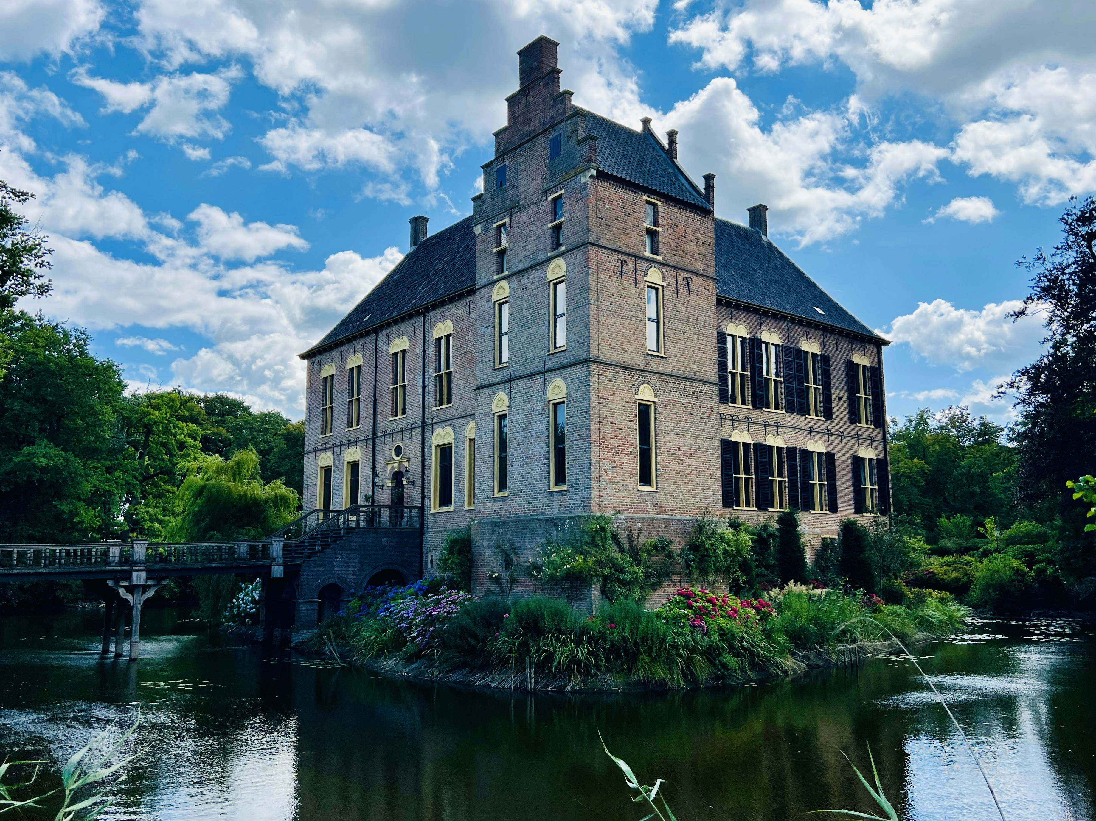 Beautiful castle | A historic brick castle surrounded by water and greenery.
