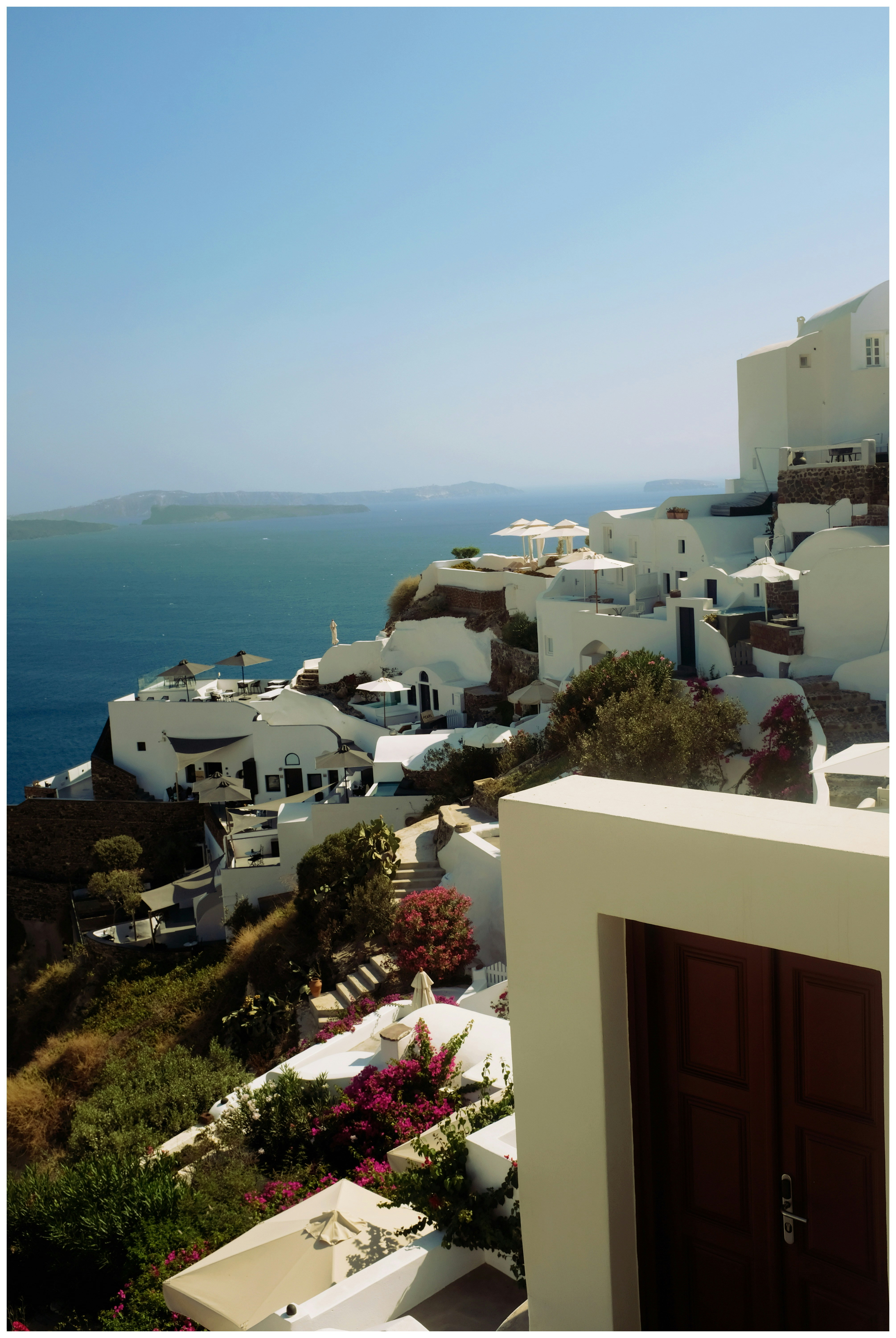 Santorini ‘25 | Whitewashed buildings cascading down a hillside to the sea.