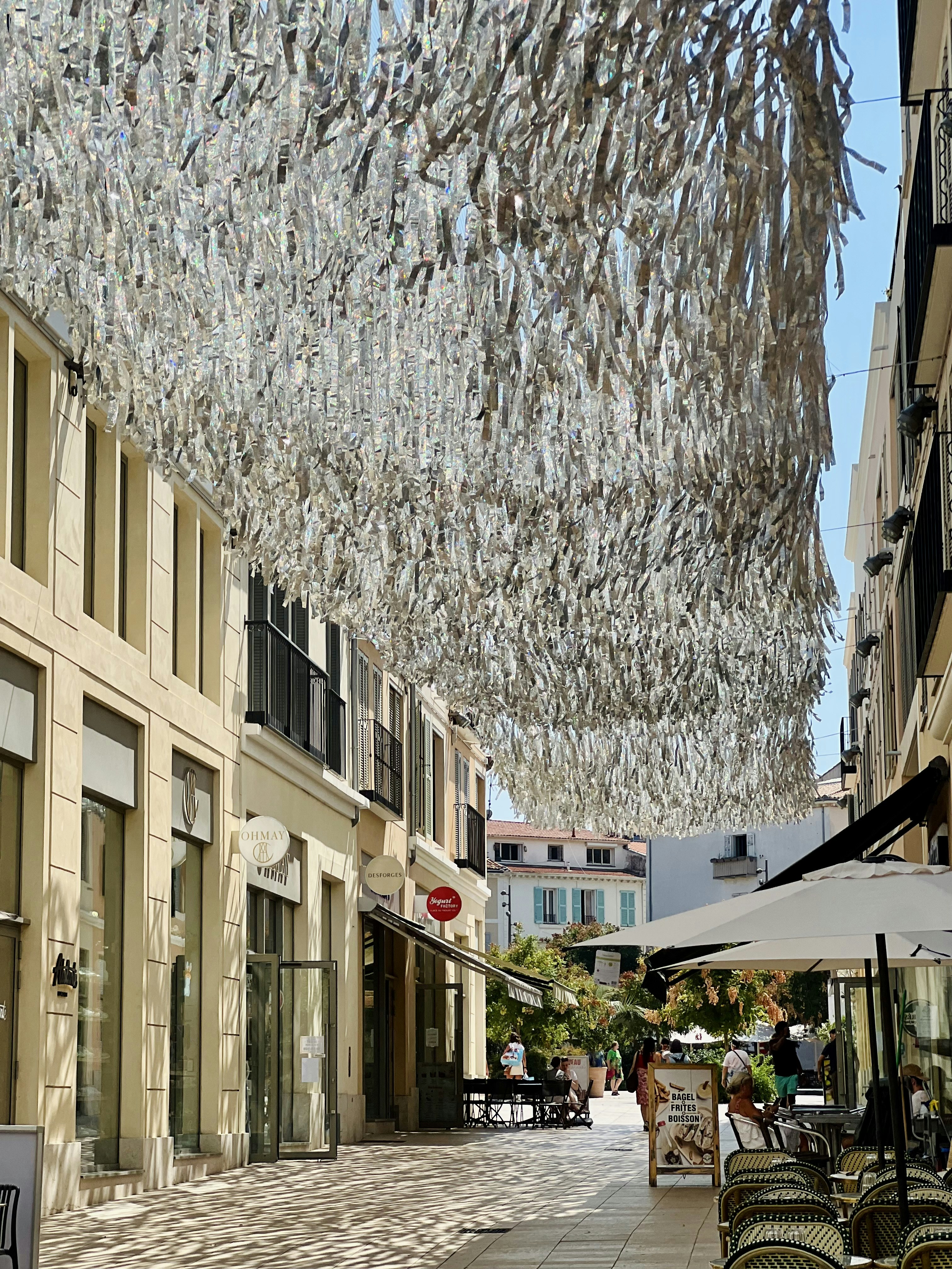 Street decorated with hanging silver streamers
