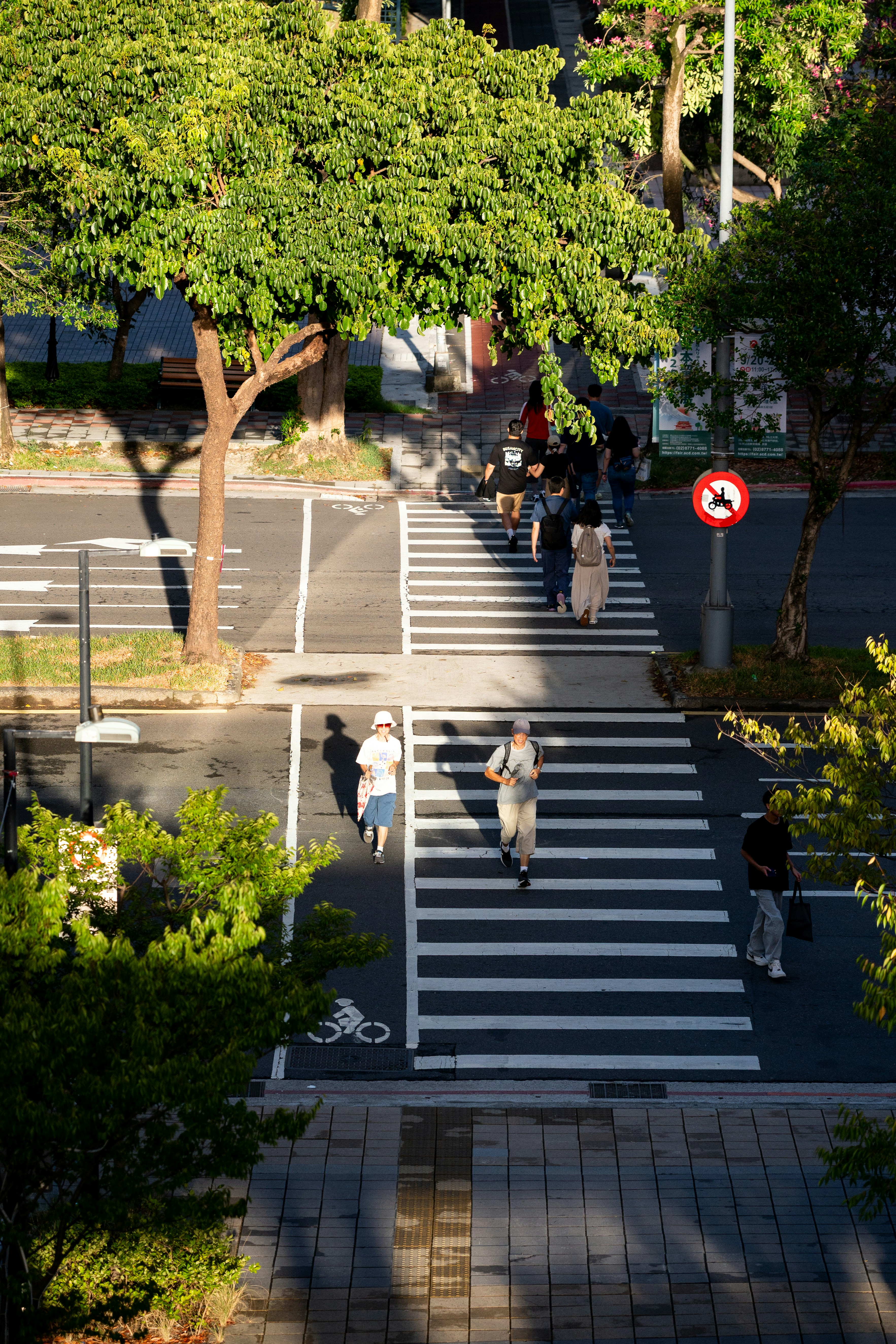People crossing a street at a crosswalk.