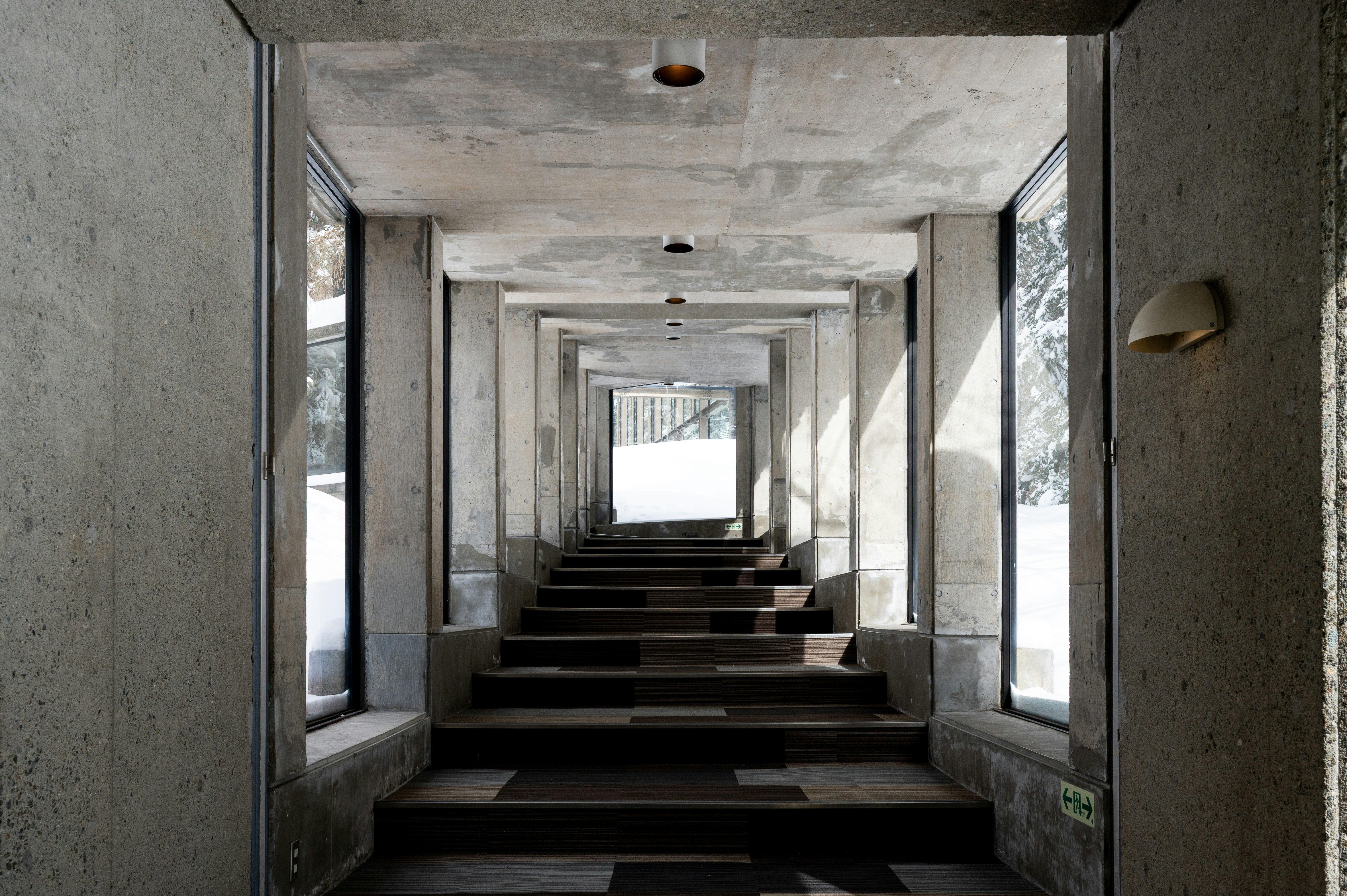 Concrete hallway with stairs and windows