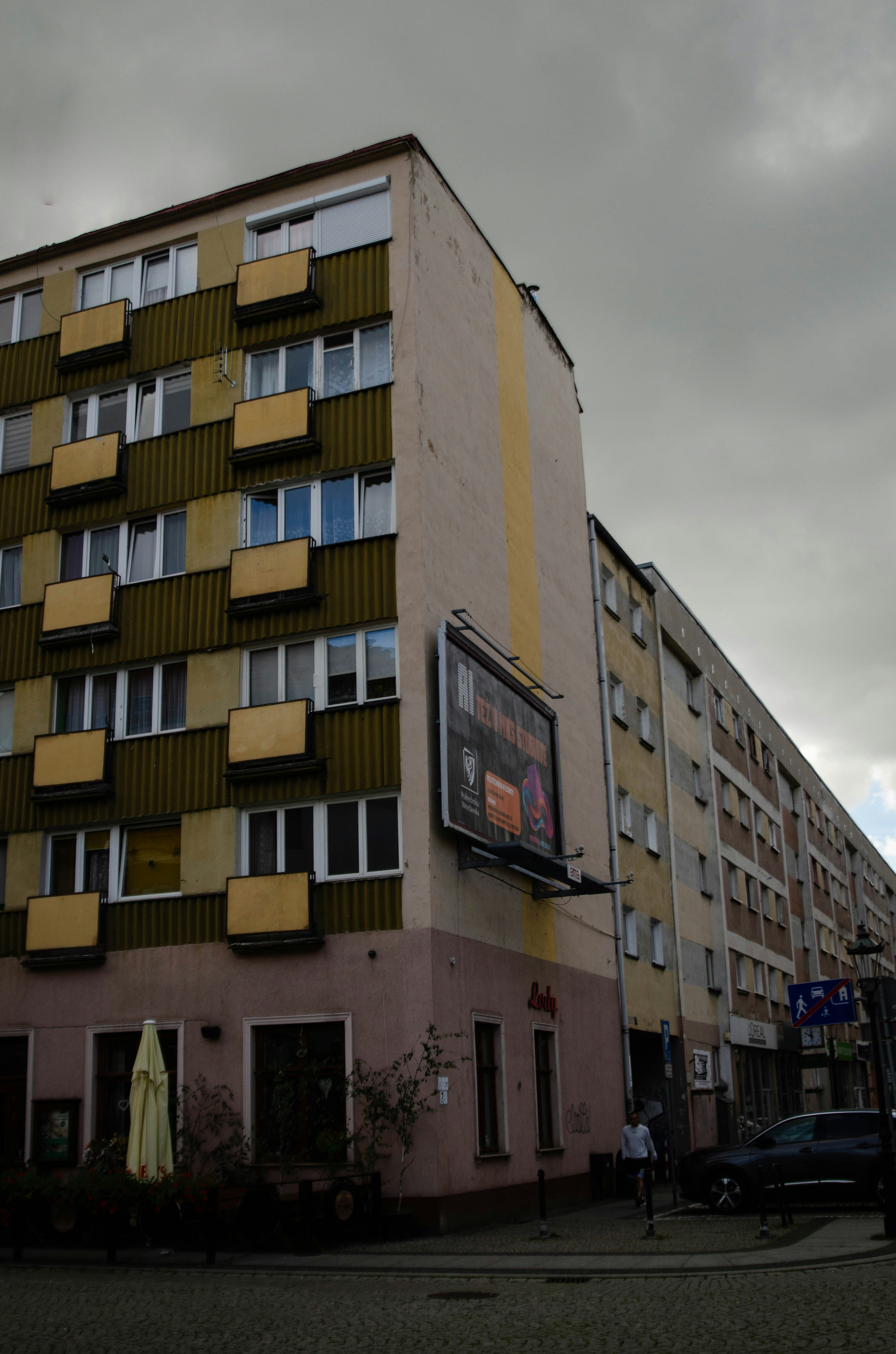 Apartment buildings with balconies under a cloudy sky