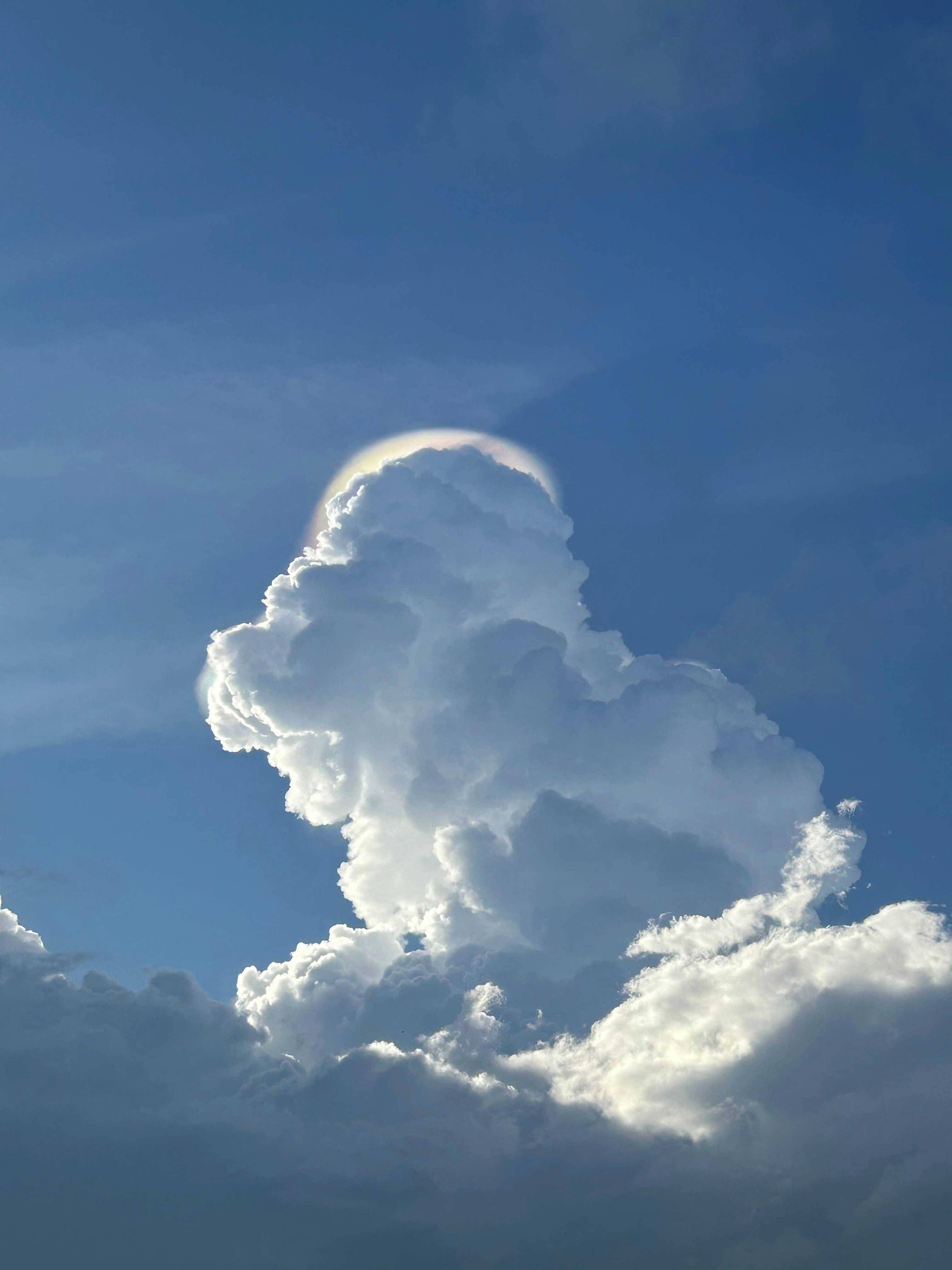 Sky | A large, illuminated cloud formation against a blue sky.
