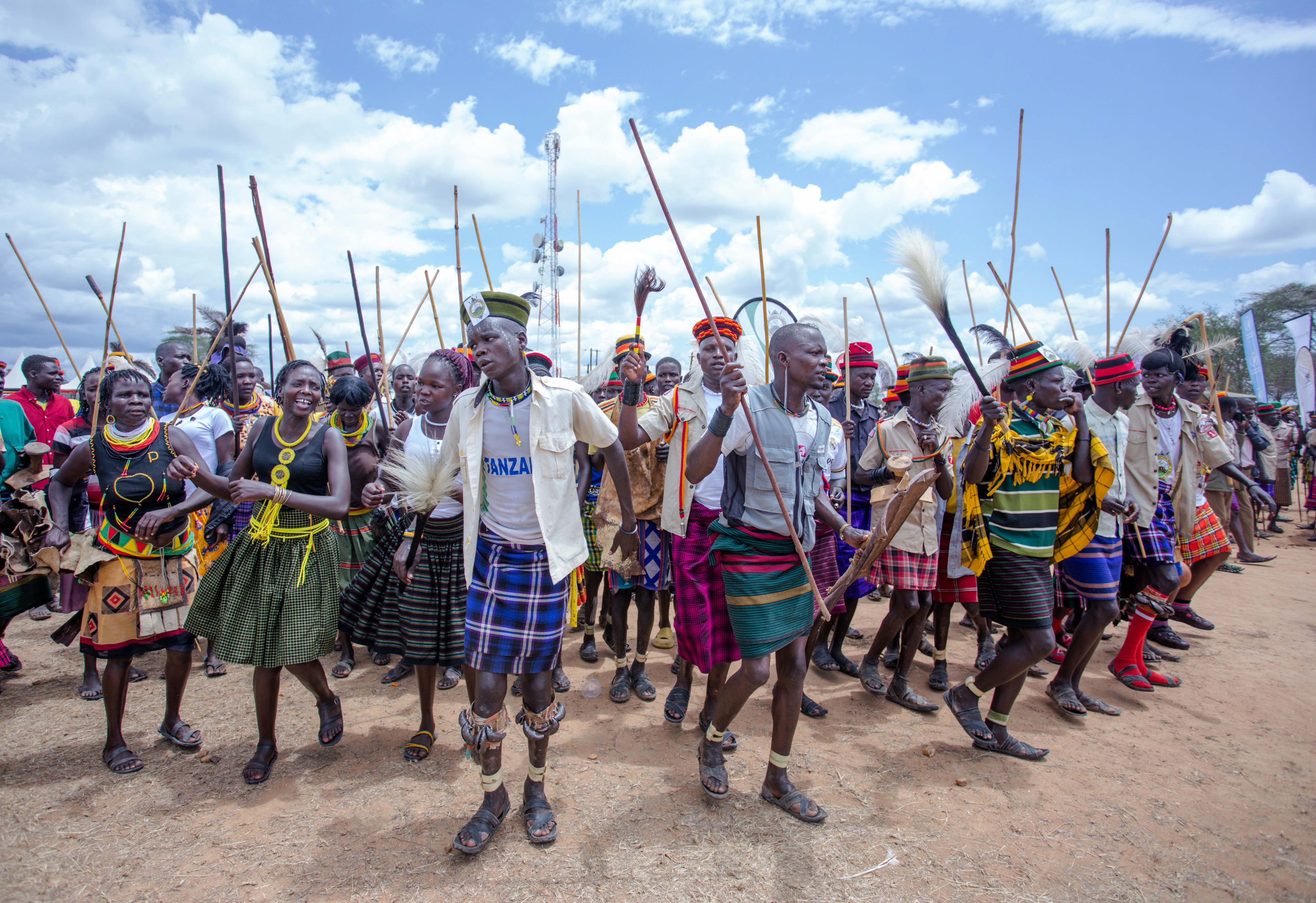 Group of people in traditional attire dancing outdoors