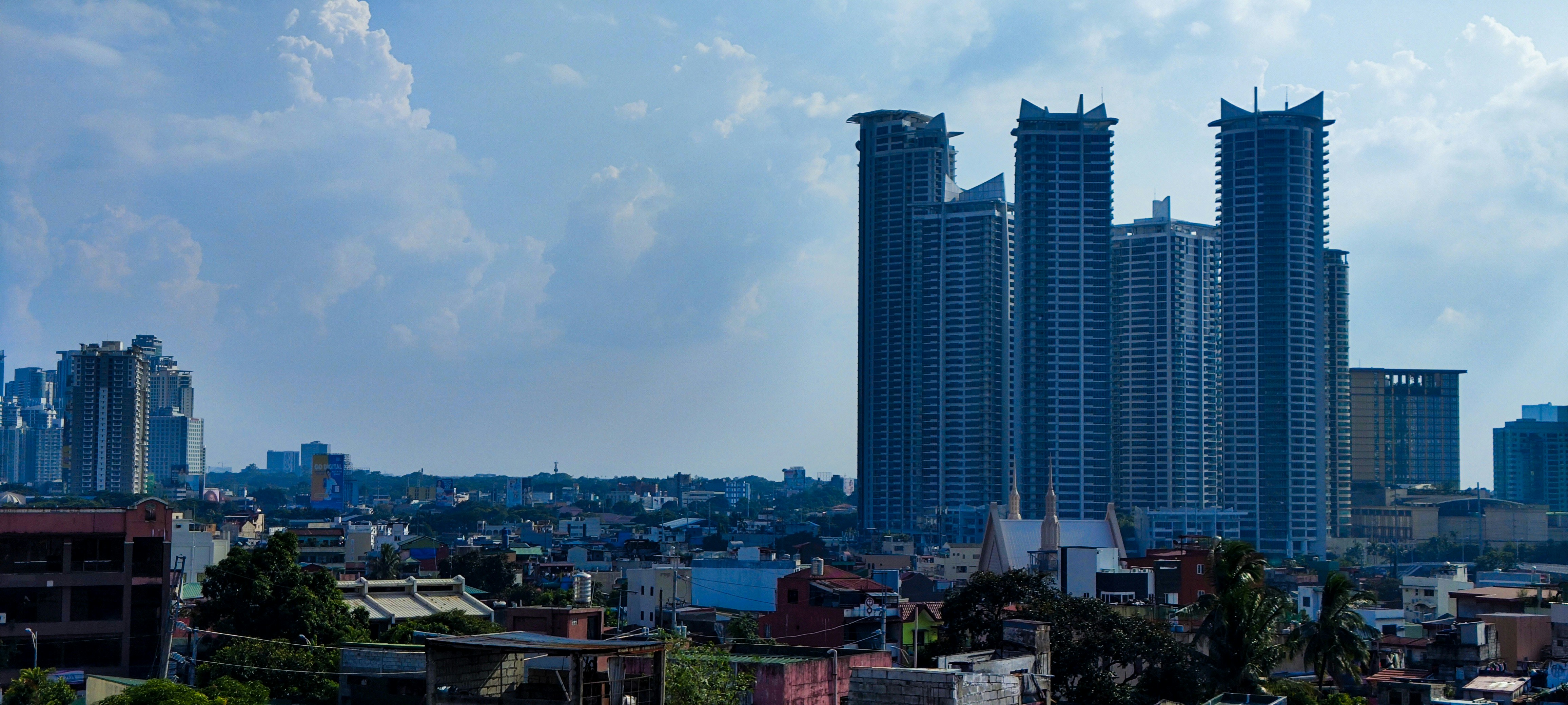 Tall modern skyscrapers rise above a cityscape.