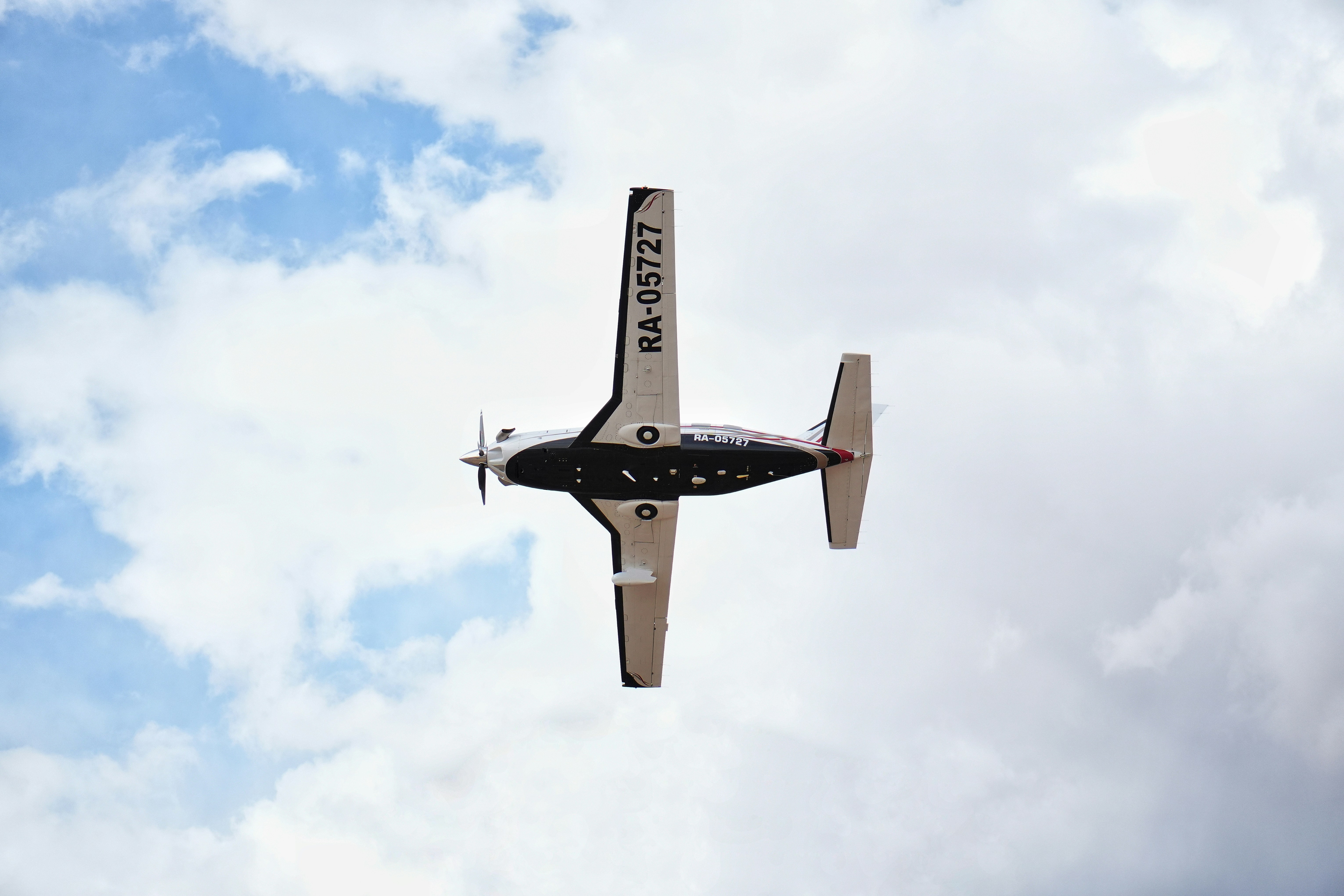 A turboprop airplane flies in the sky.