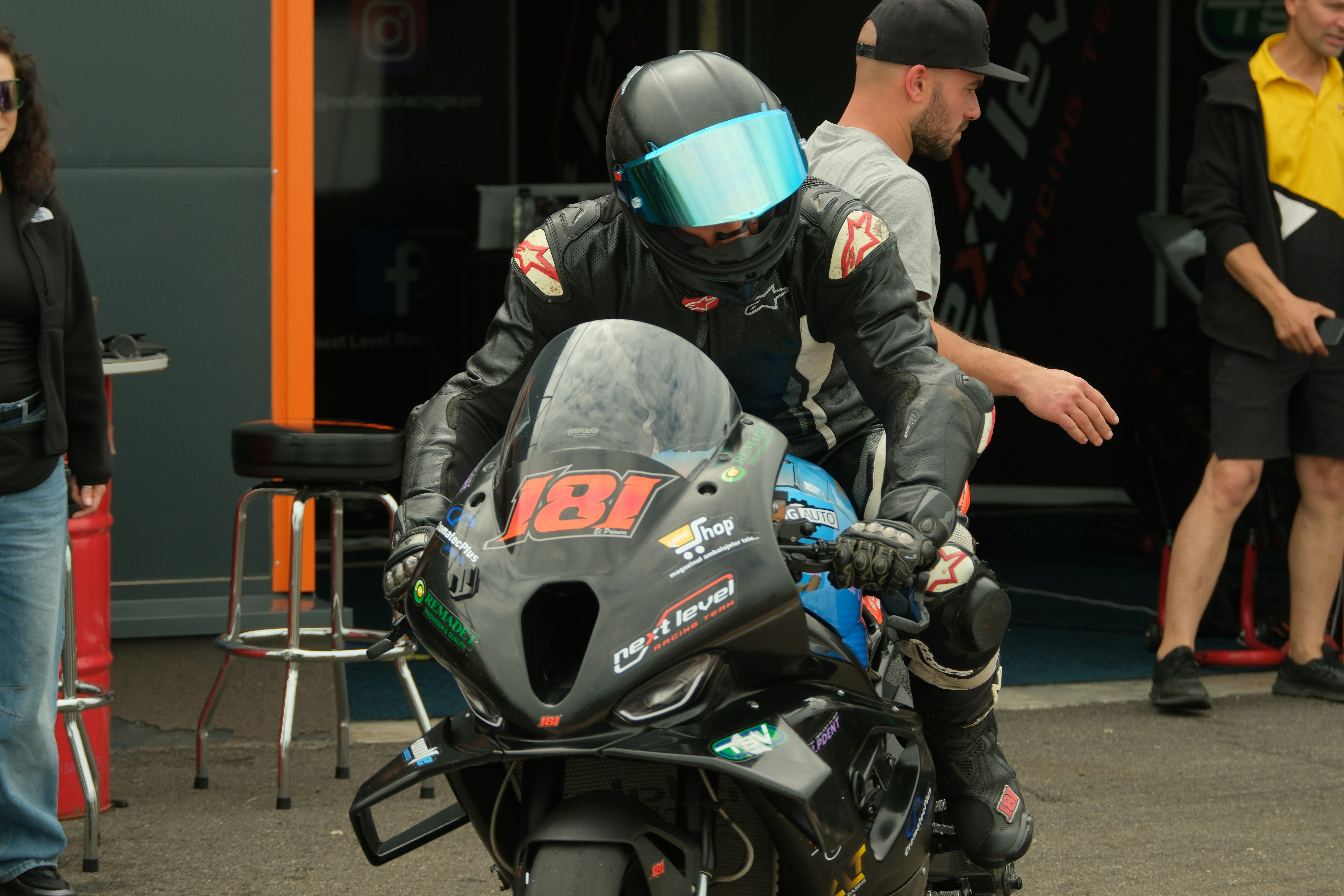 Racer on a motorcycle wearing full gear