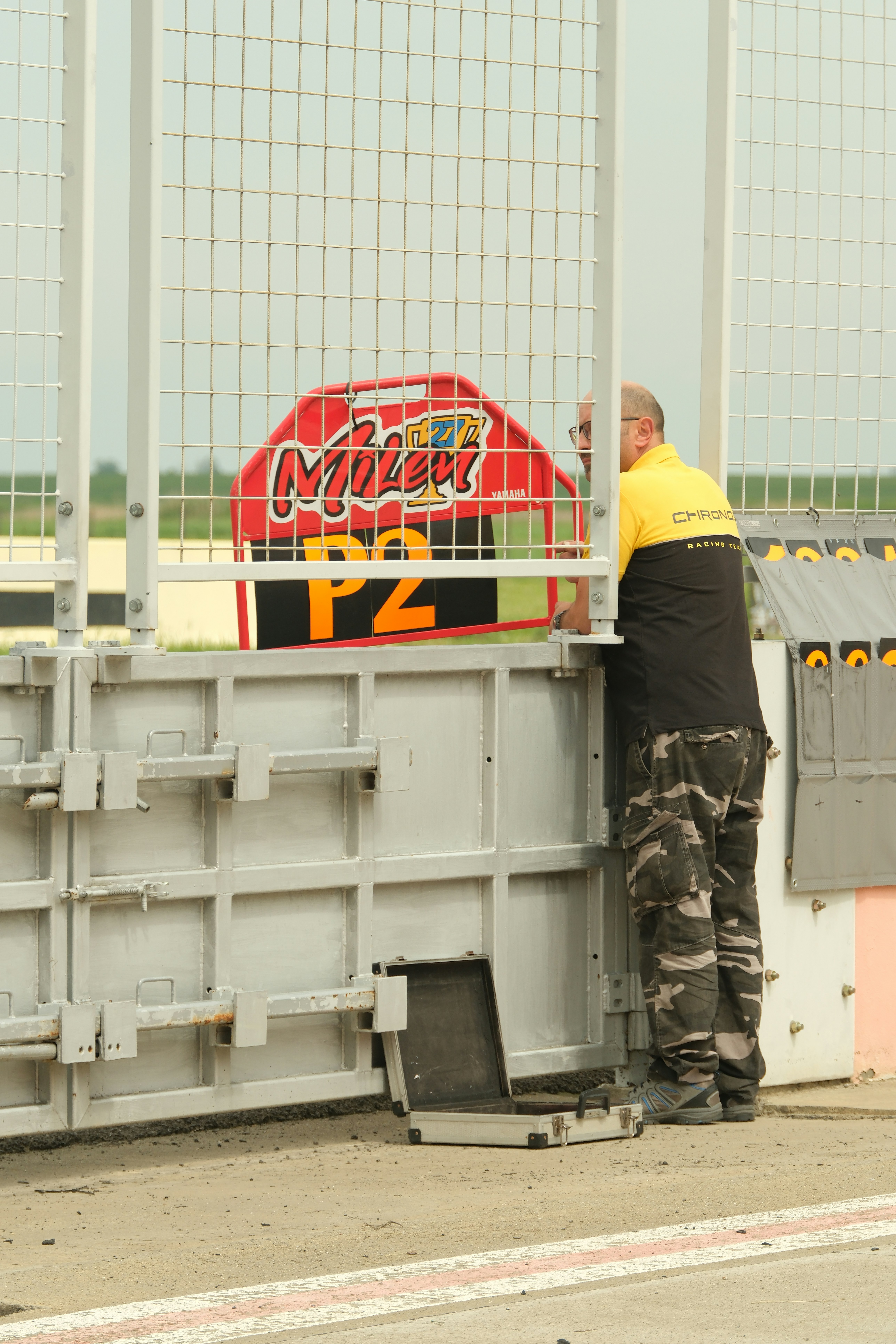 Man in yellow shirt at race start gate