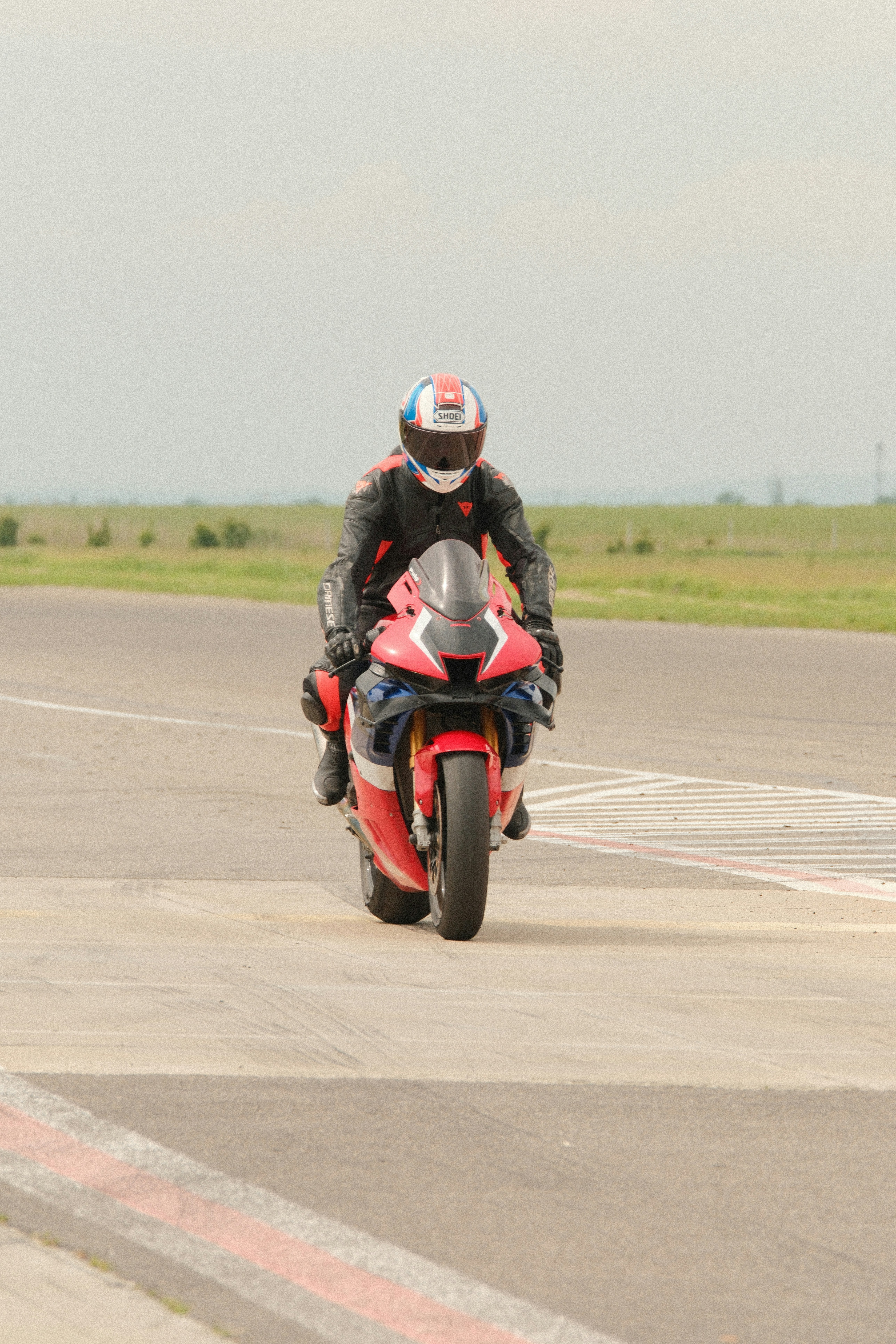 Red Blur on the Open Circuit: A Lone Rider Powers Toward the Horizon