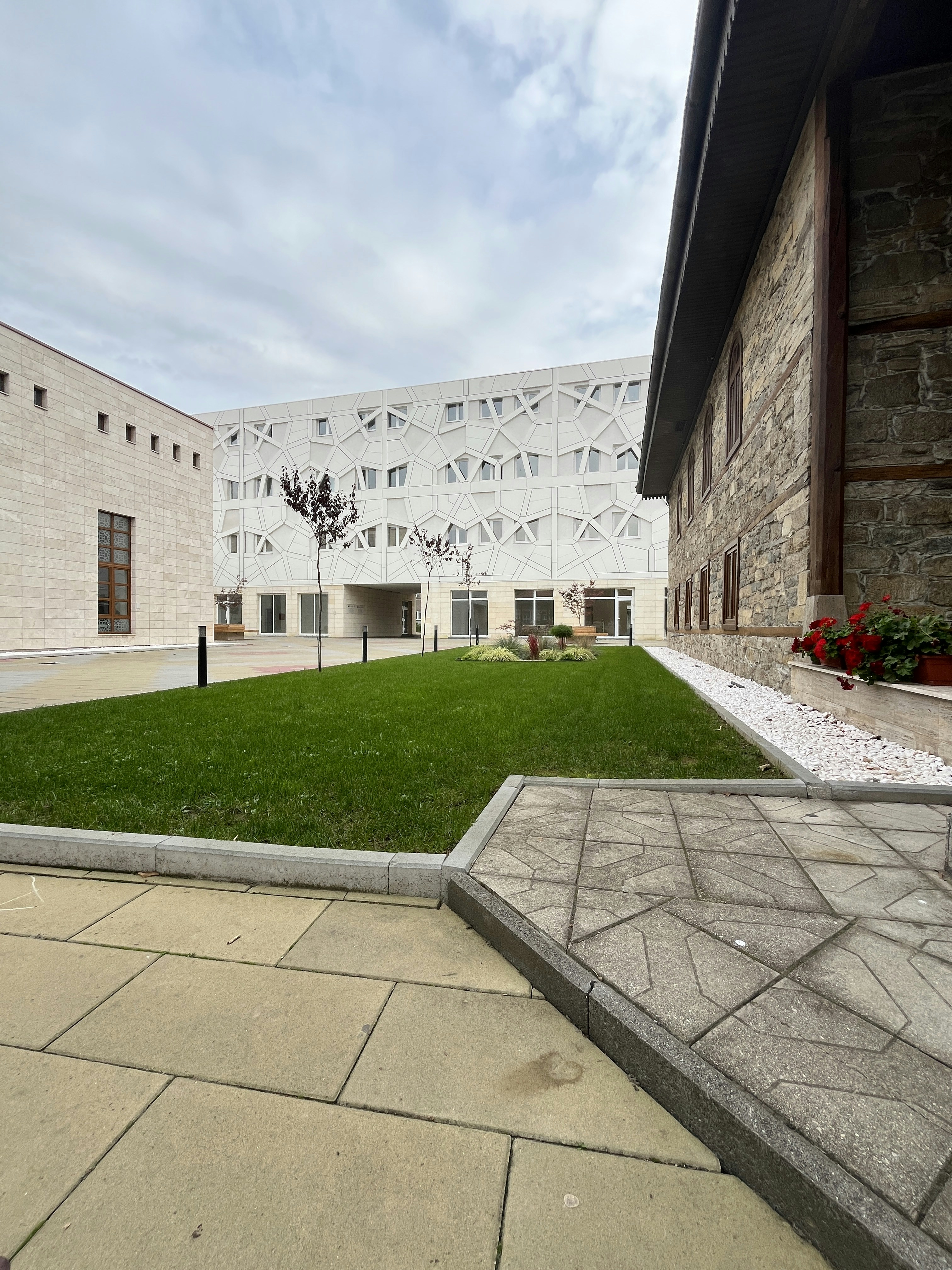 Islamic center Sultan Ahmed | Modern white building adjacent to old stone structure