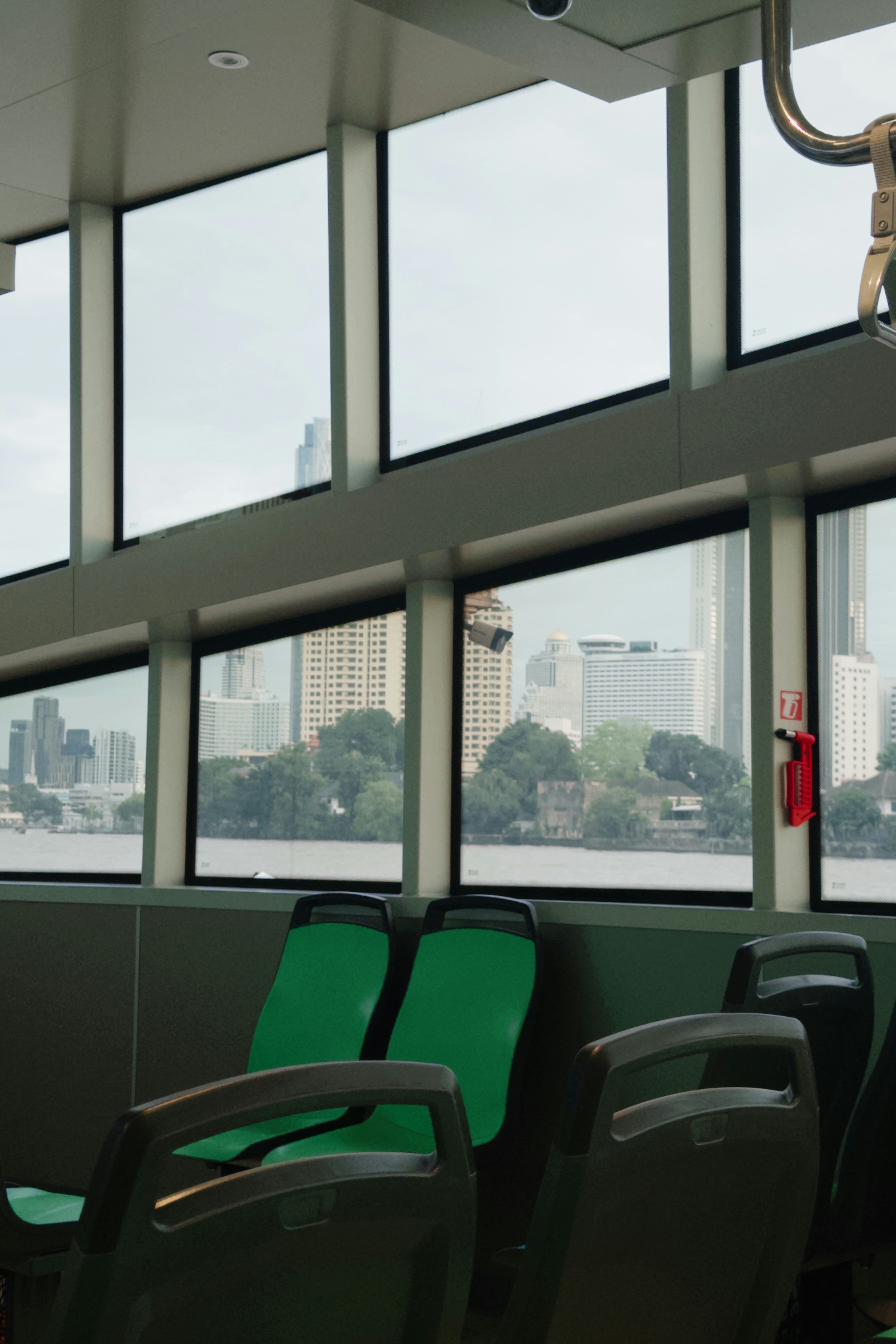 Empty seats on a ferry with city view