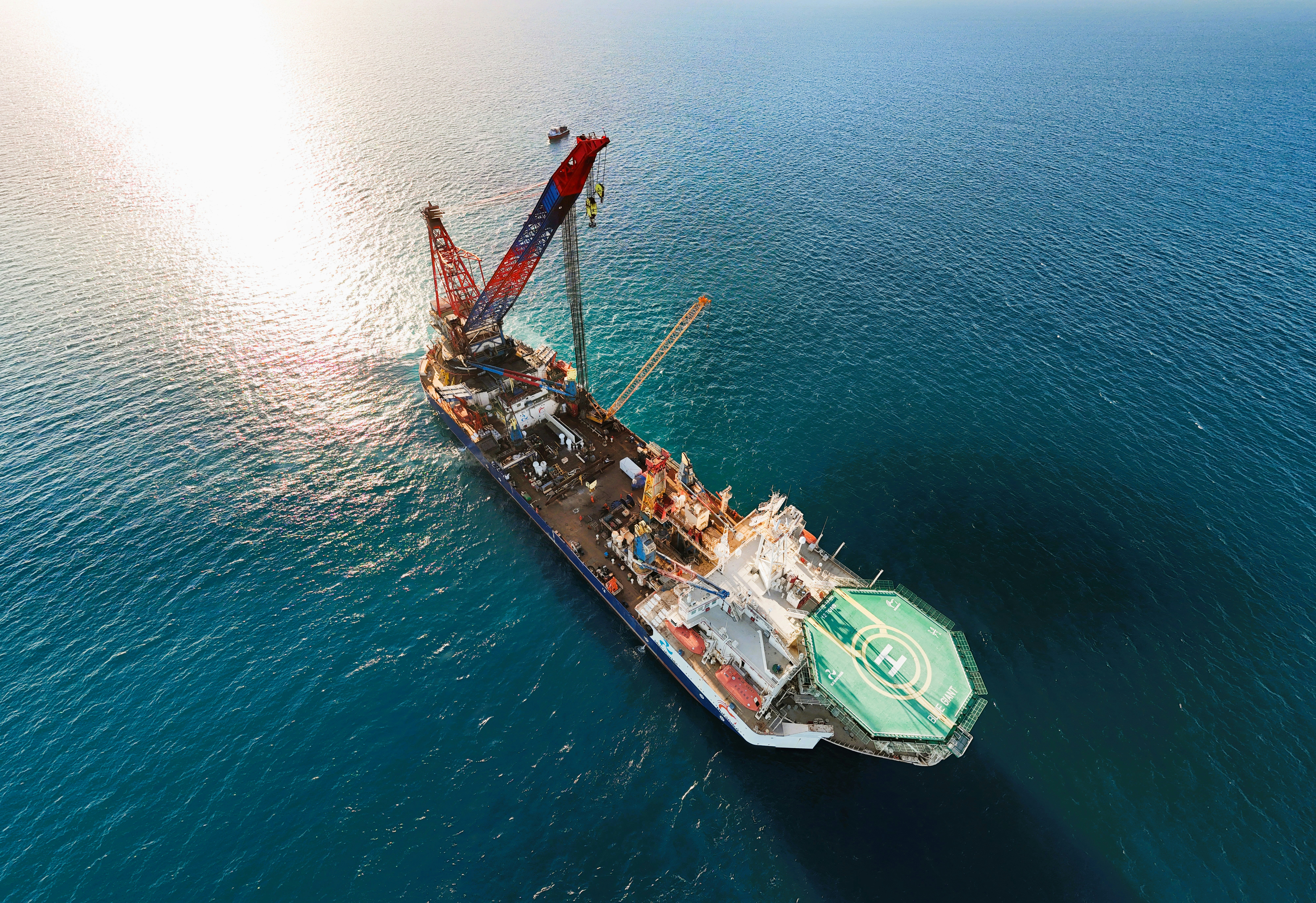 Blue Giant. | A large construction vessel with a crane at sea