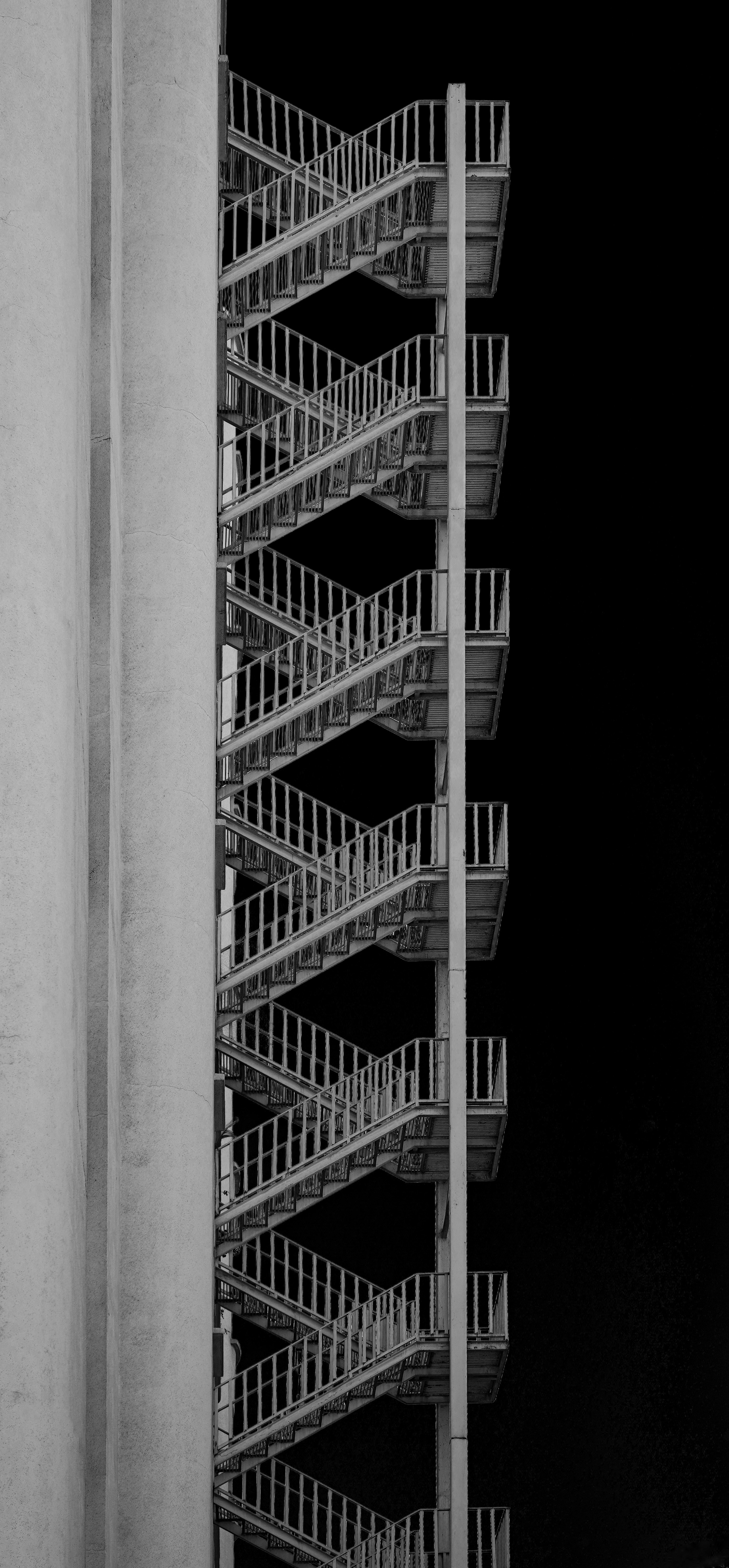 Exterior metal staircase against a dark background
