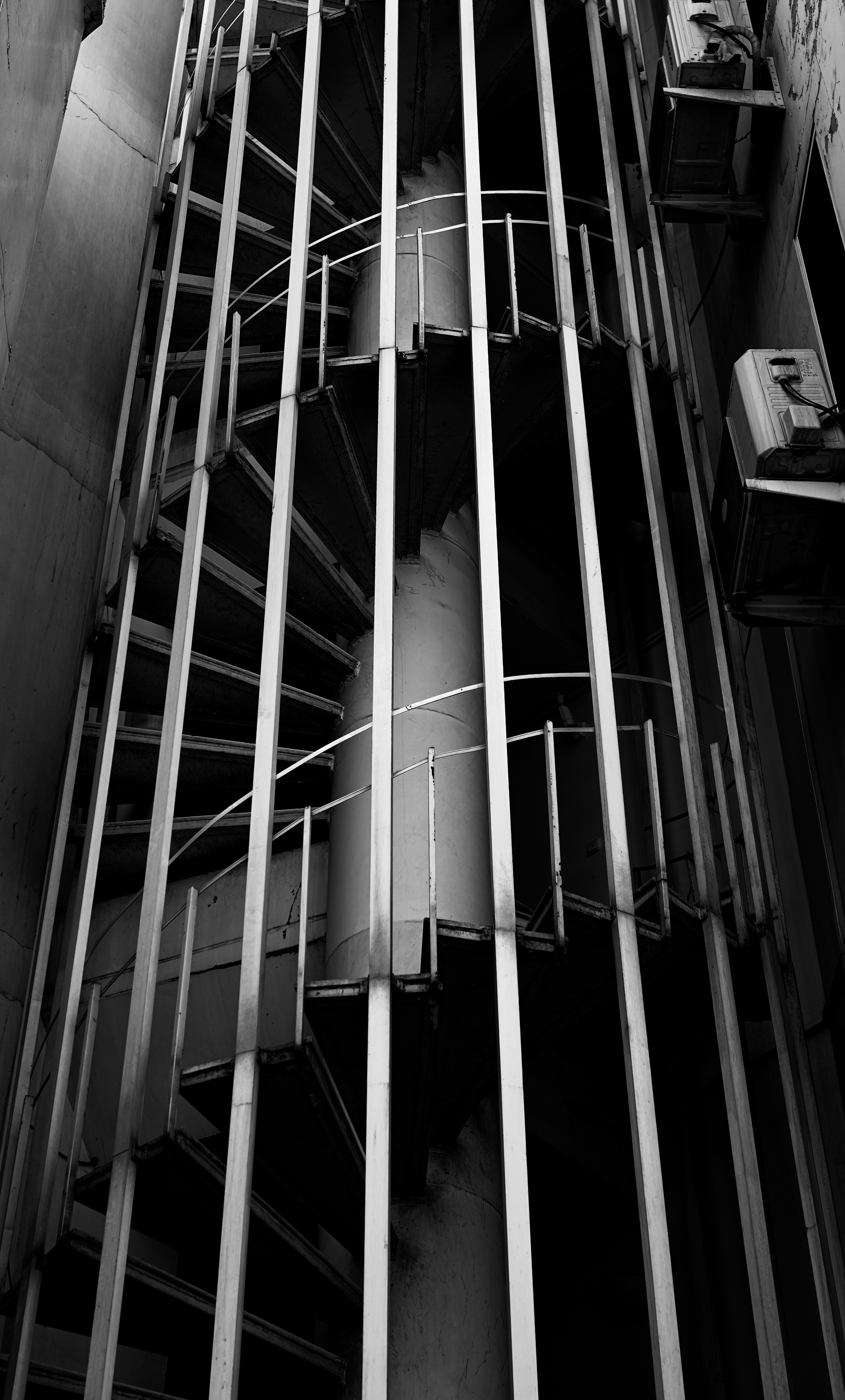 A black and white spiral staircase with metal railings.