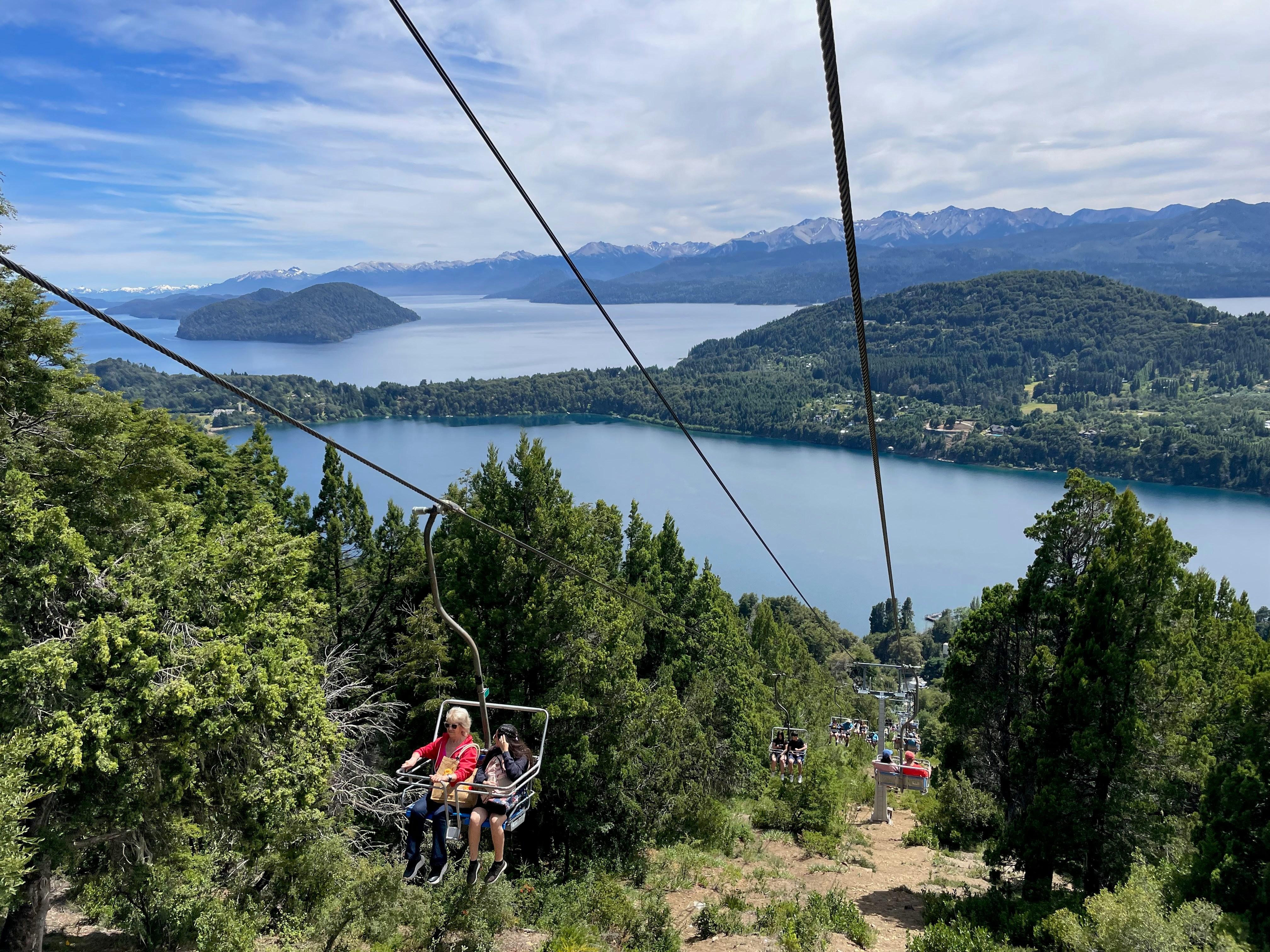 Ridge Glide to a Sapphire Lake: Chairlift Pass Above Pine Slopes