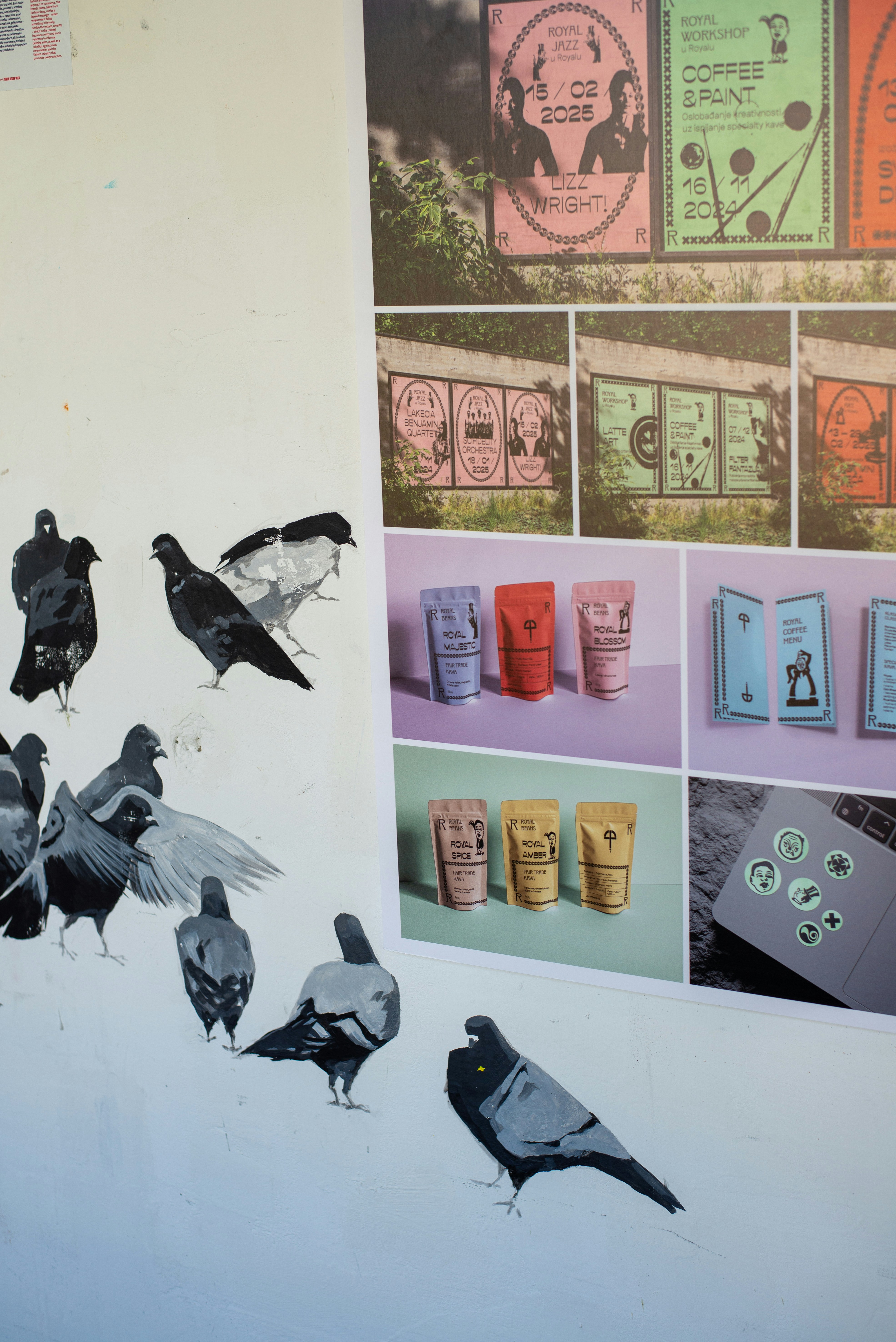 Pigeons painted on a wall next to posters and tubes