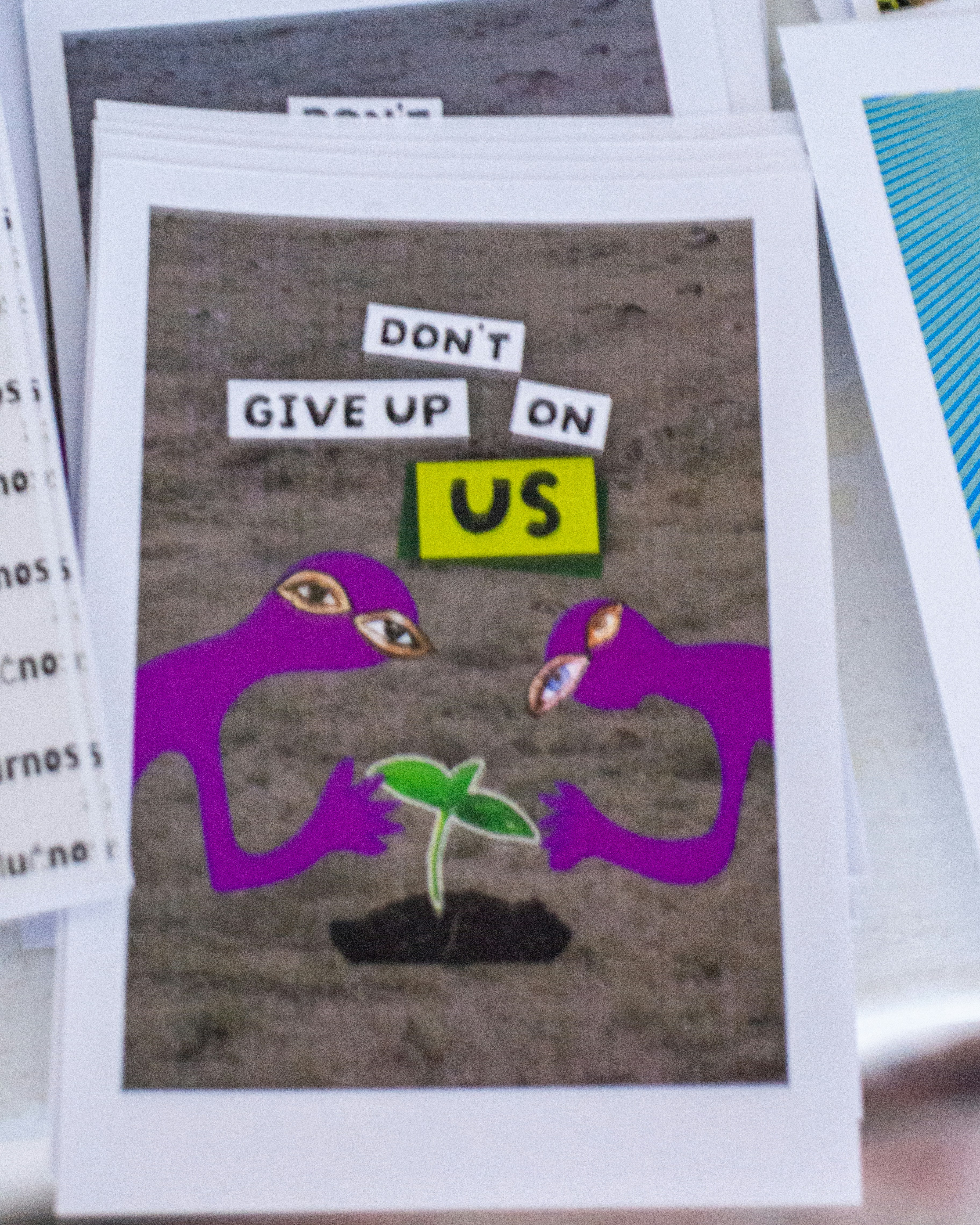 Two purple aliens tending a small plant