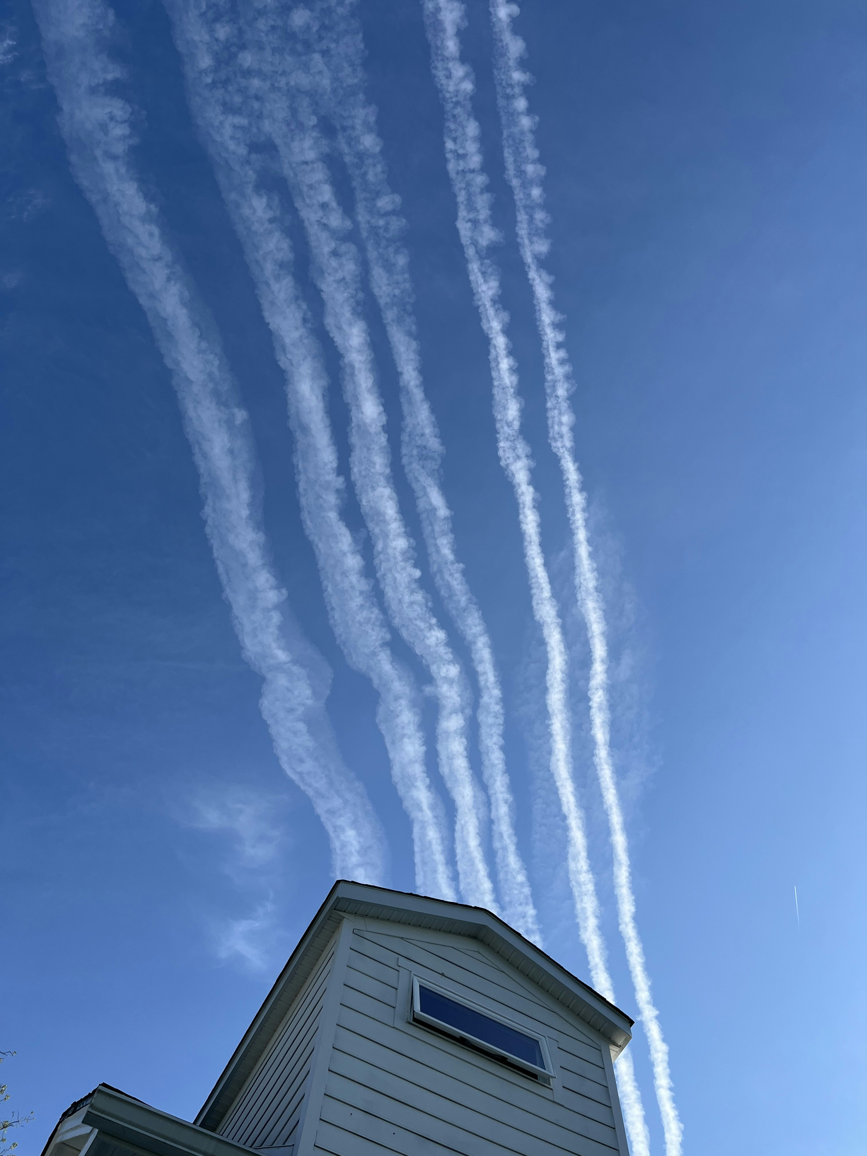 Skyward Trails: A Dance of Clouds and Architecture