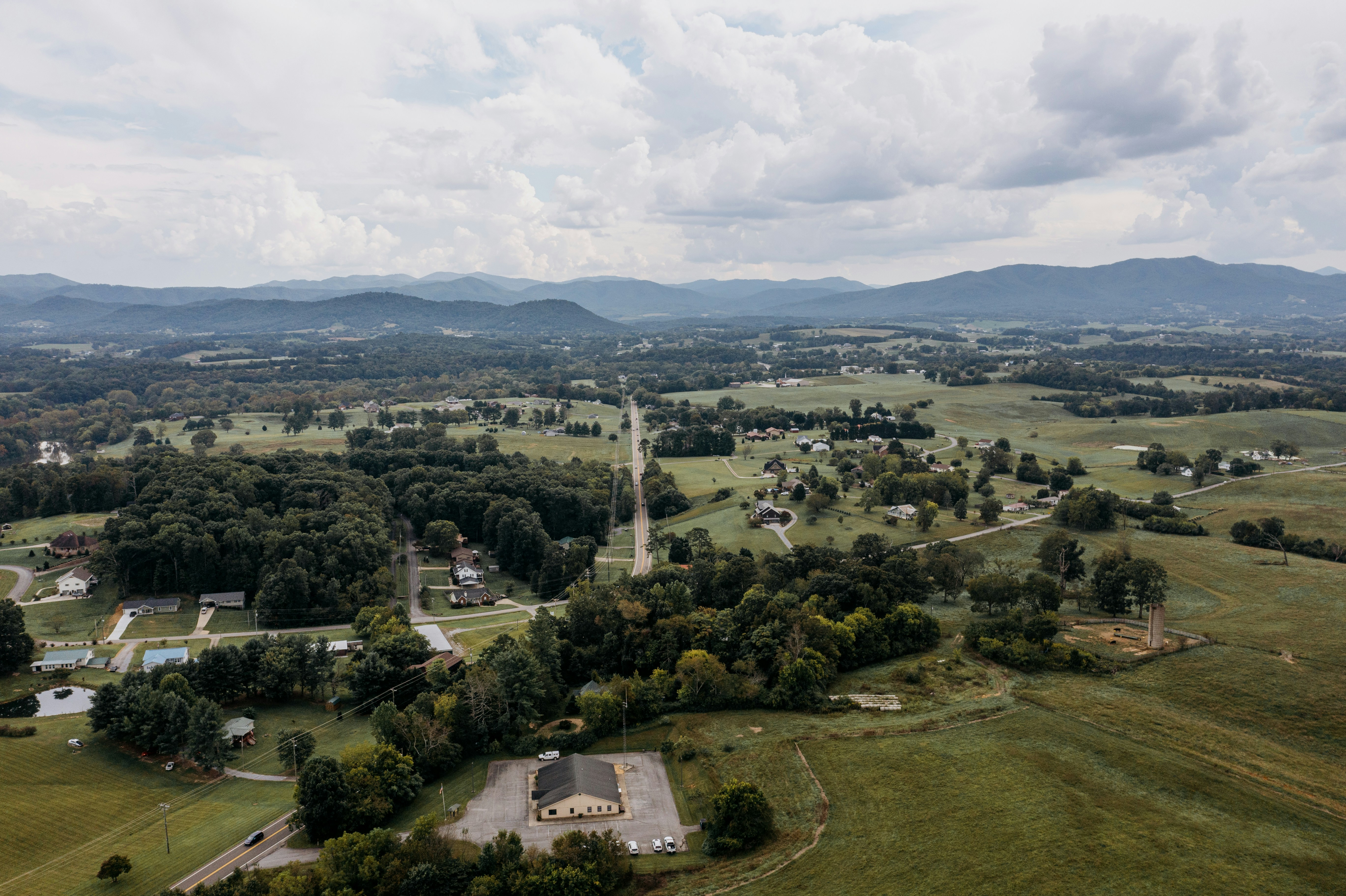 Aerial view of a rural town nestled among rolling hills.