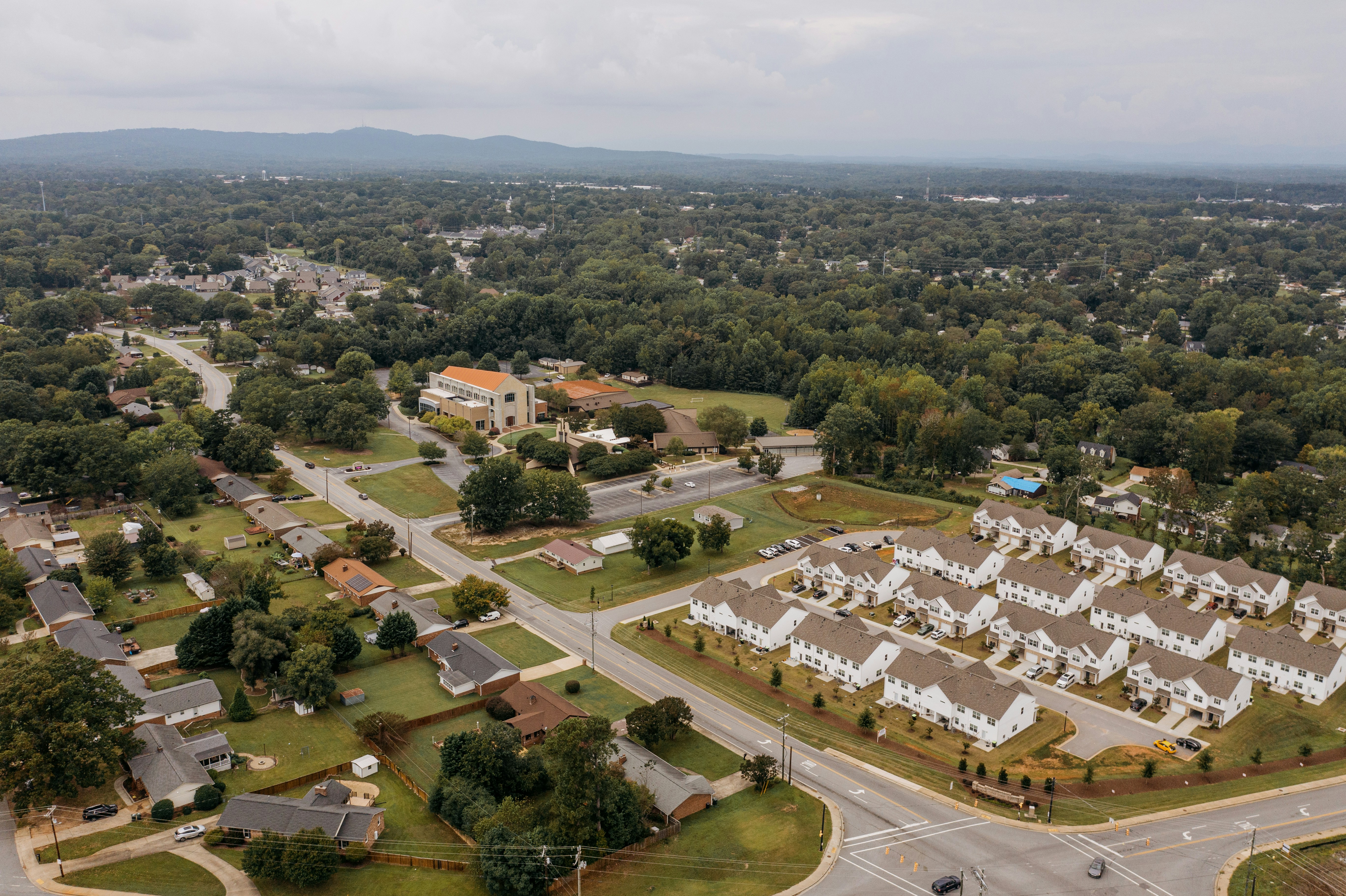 Aerial view of suburban neighborhood with houses and trees.